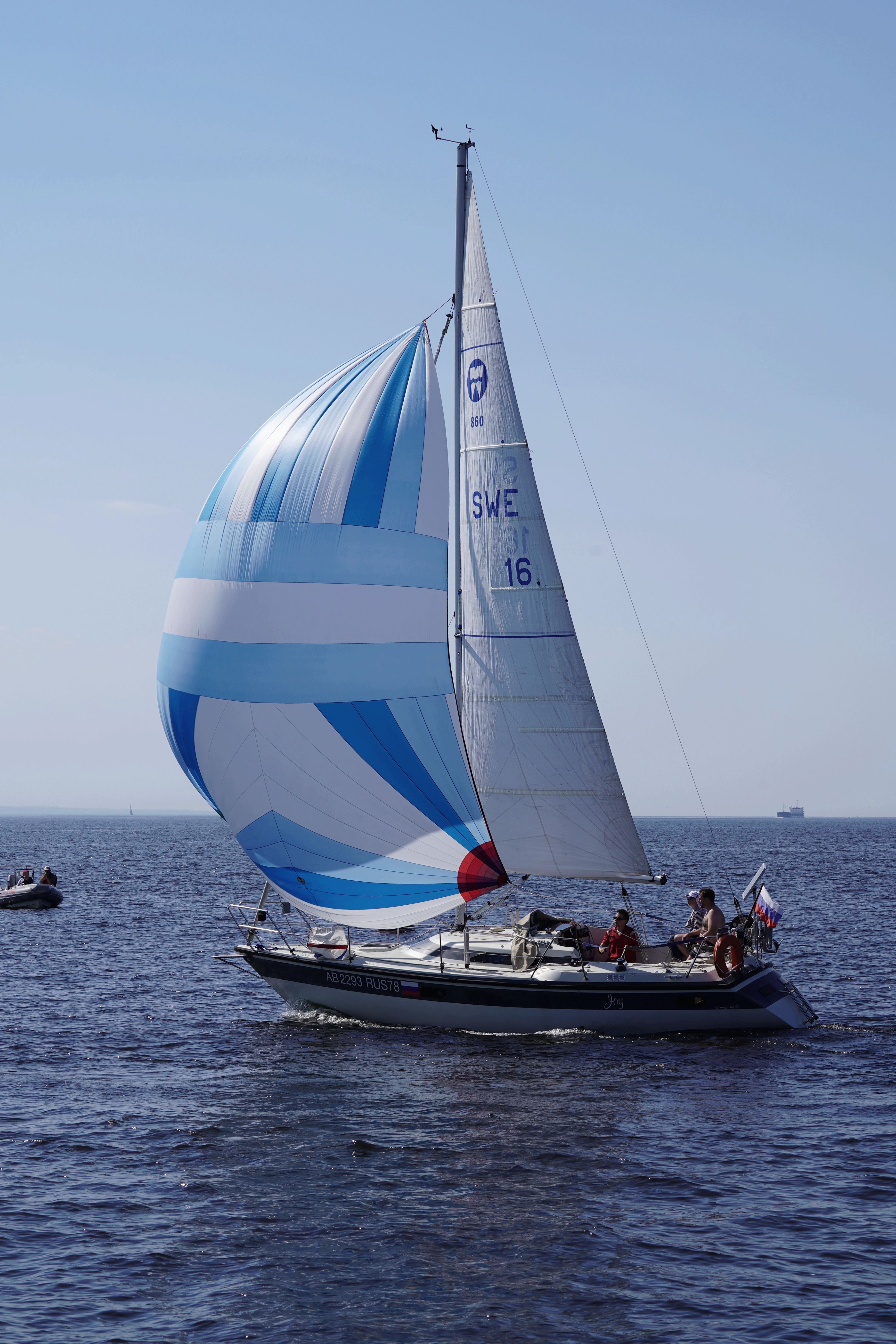 Person in Blue and White Sailboat on Body of Water during Daytime ...