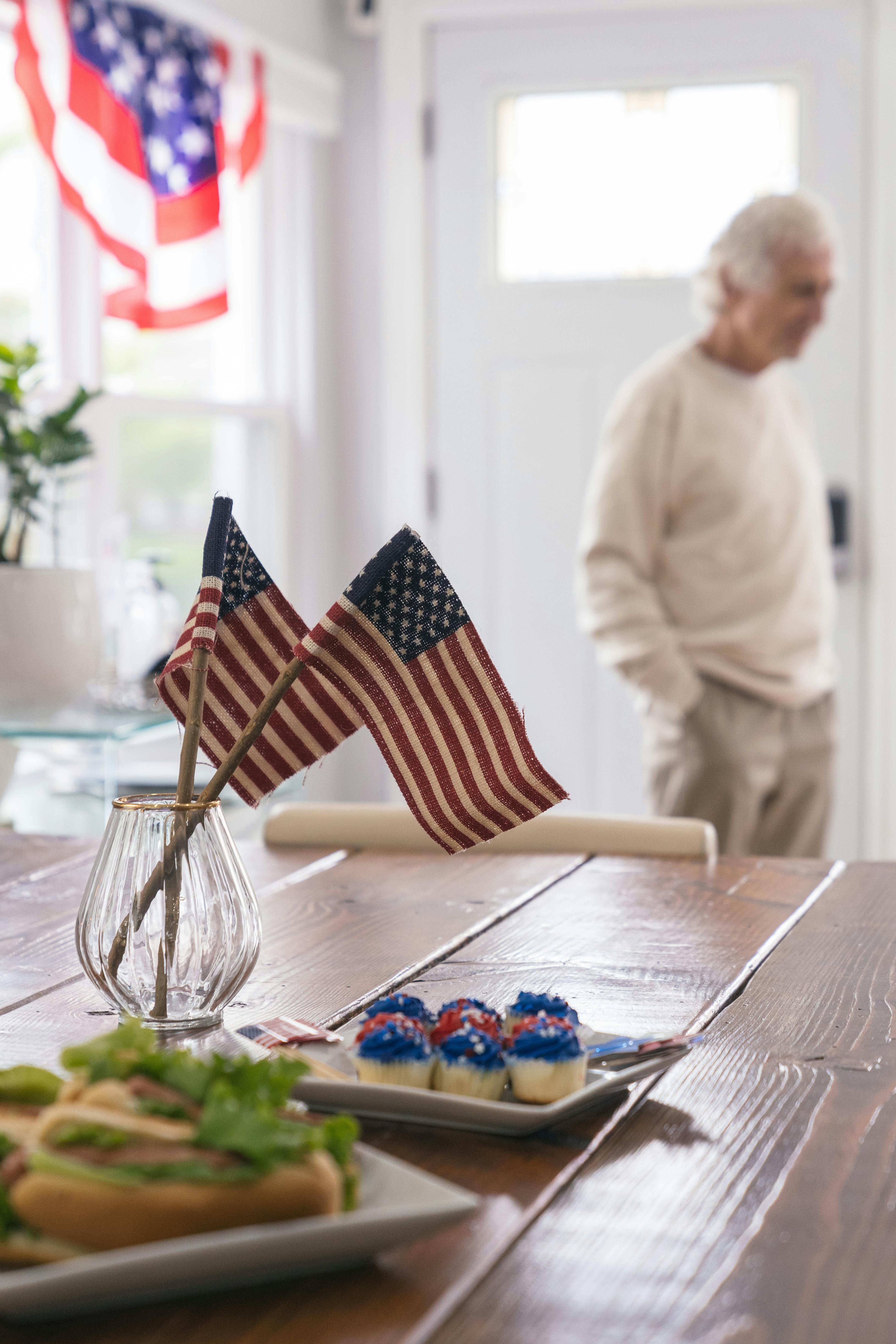 American Flags in a Clear Vase on Top of Wooden Table · Free Stock Photo
