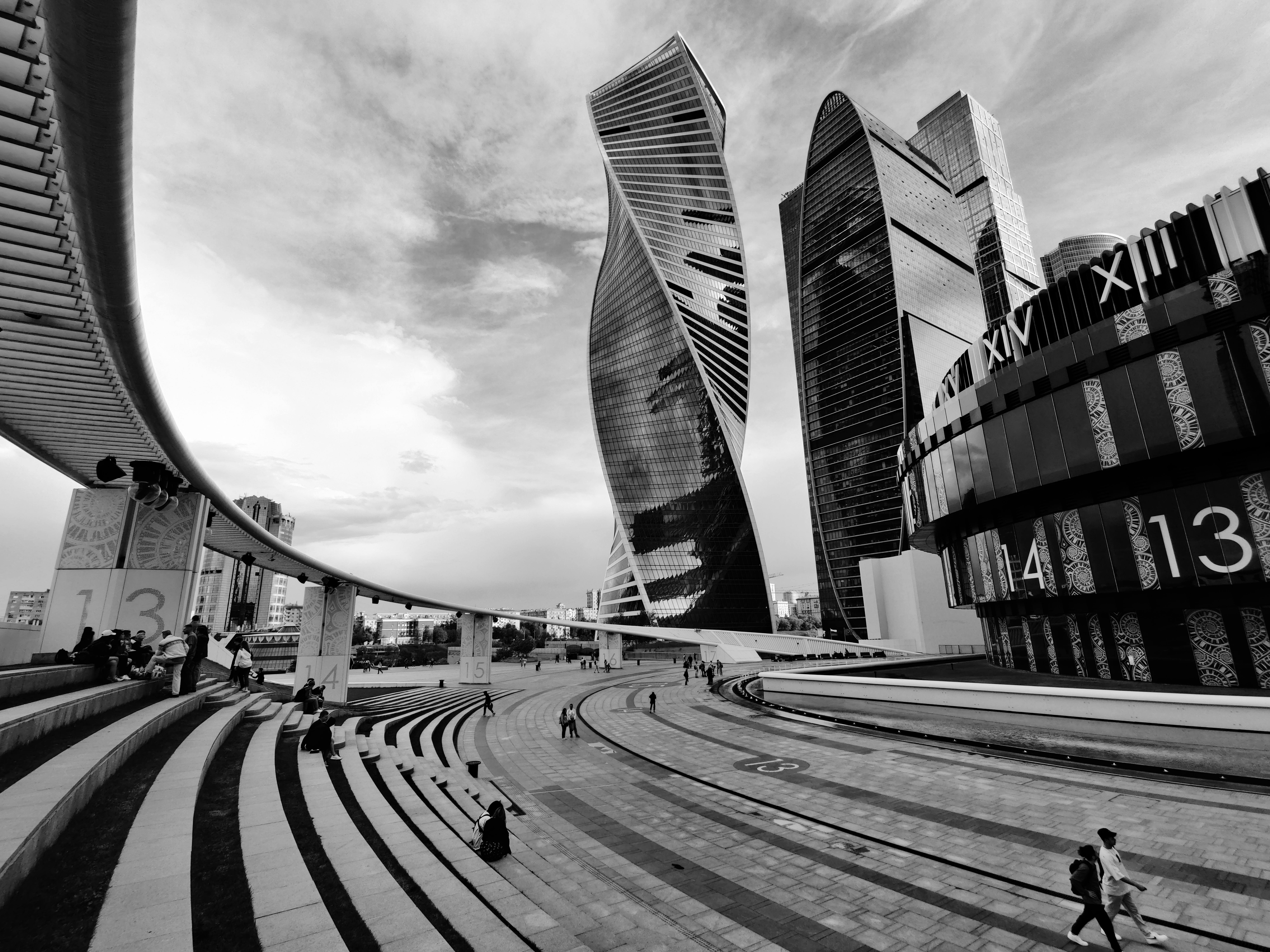People Walking on the Street Between High Rise Buildings · Free Stock Photo