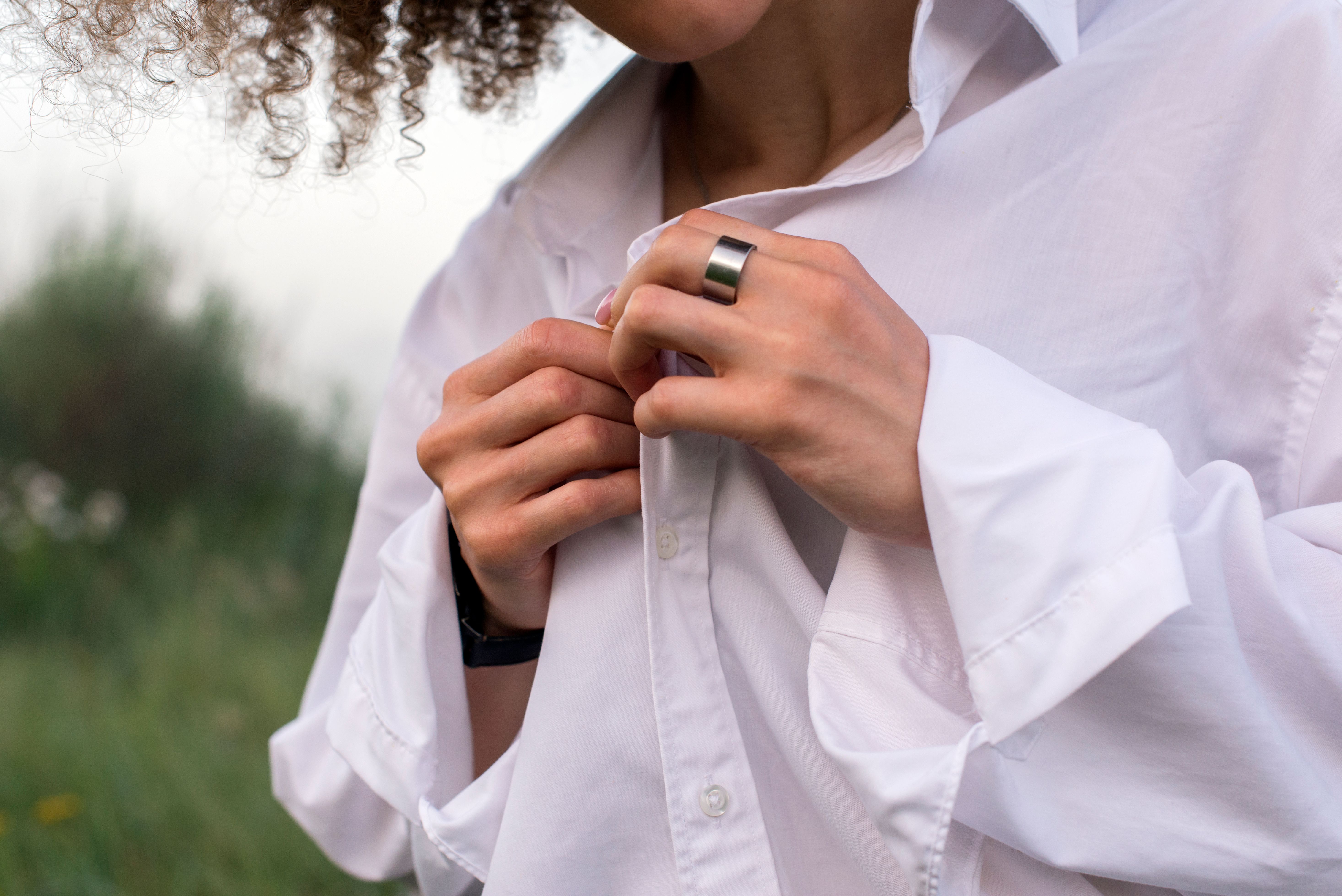 Close-Up Photo of a Person Buttoning a White Dress Shirt · Free Stock Photo