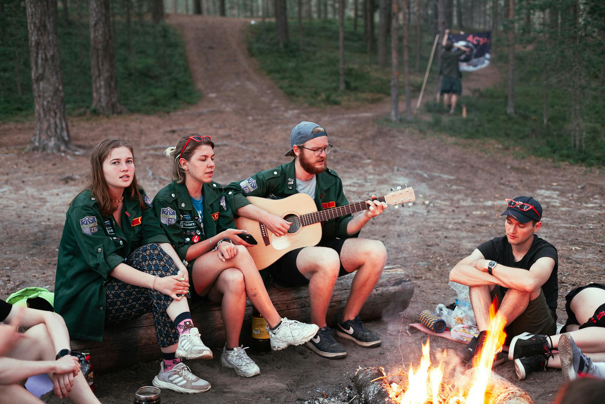 Group of Friends Sitting on Beach Sand · Free Stock Photo
