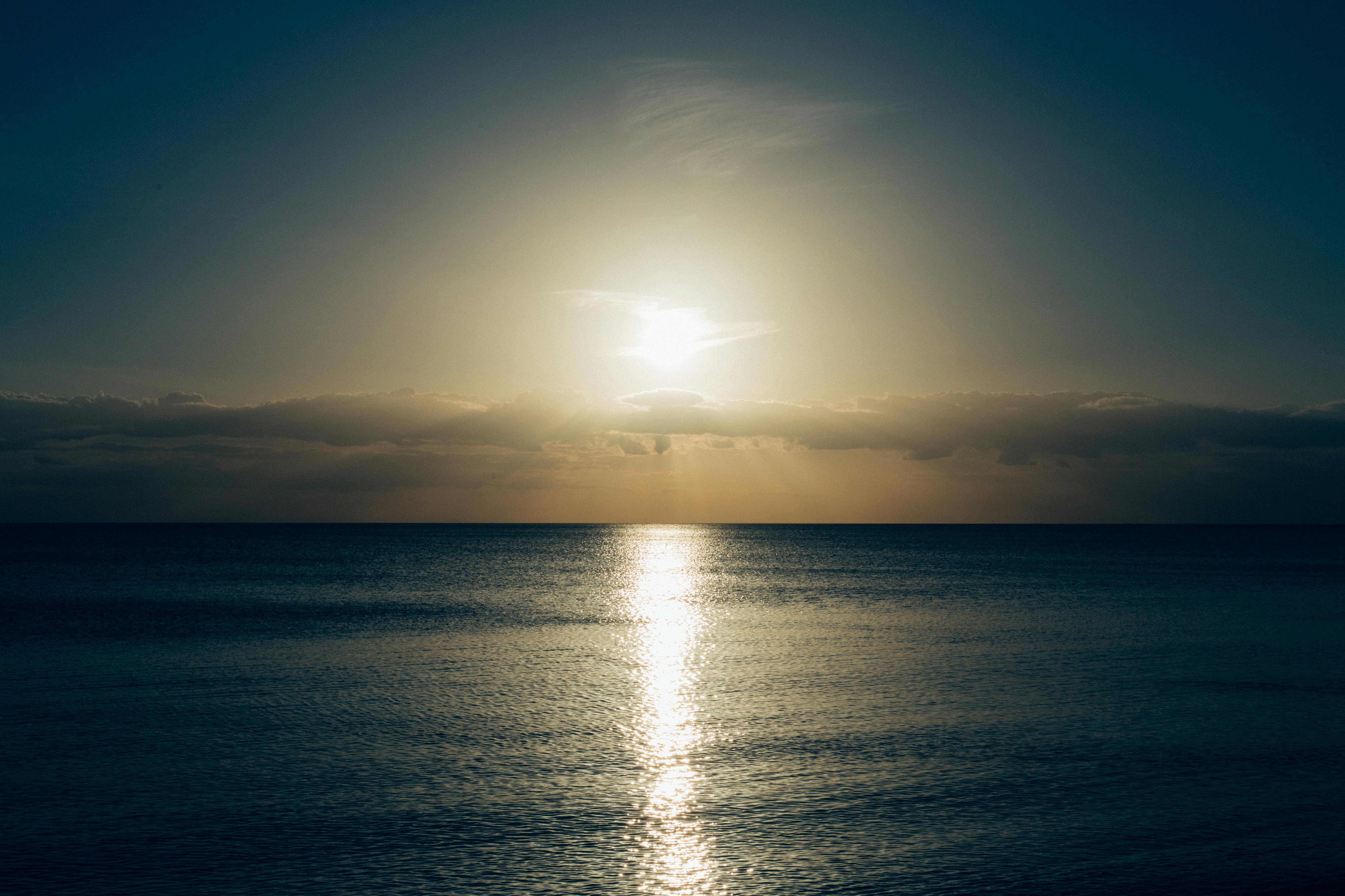 Calm Sea With Sun Setting Photo · Free Stock Photo
