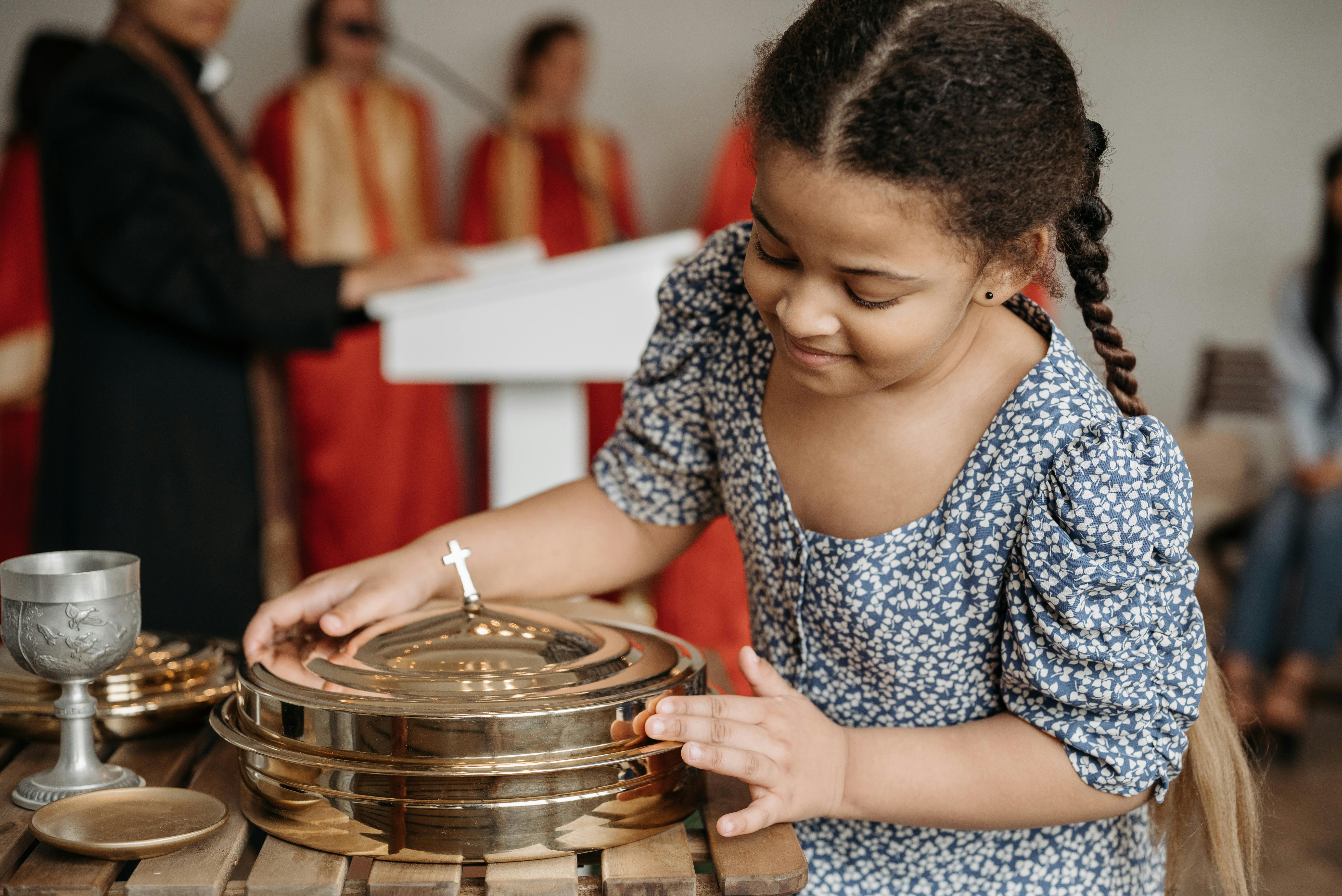 Little Girl with Braids Opening a Communion Tray in a Church · Free ...