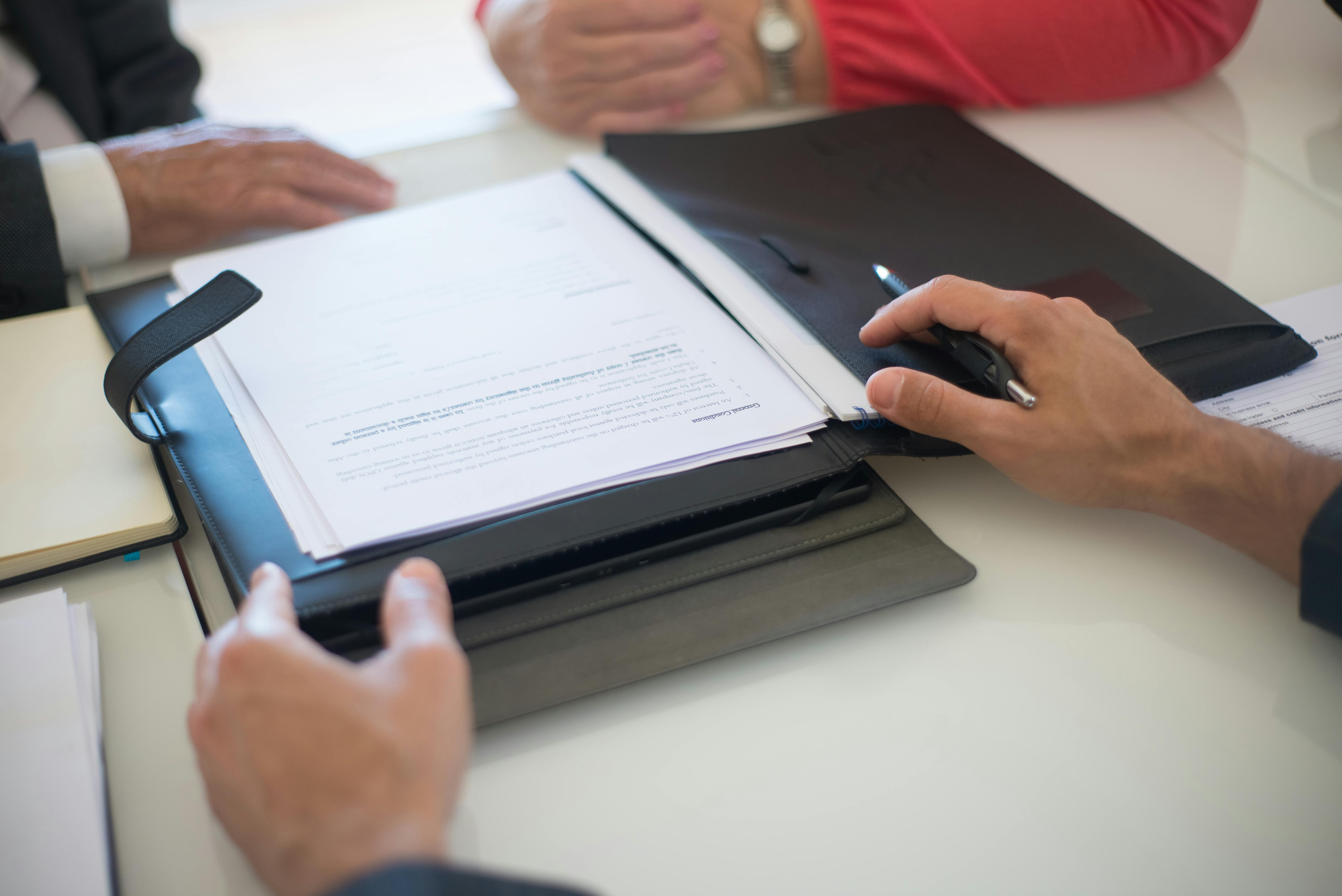 Man Hands on Table showing Contract Papers · Free Stock Photo