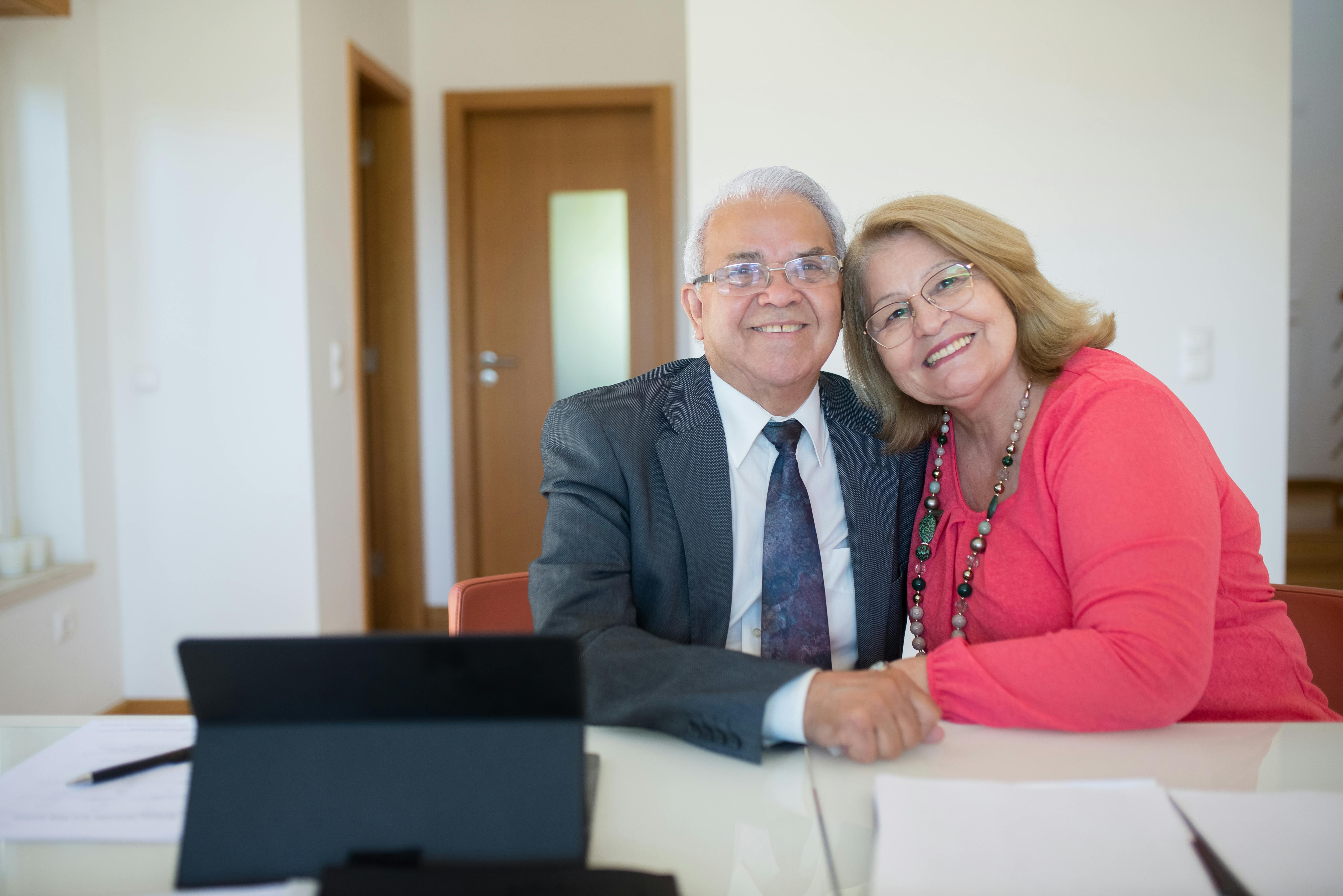 Happy Senior Couple Sitting Inside a Conference Room · Free Stock Photo