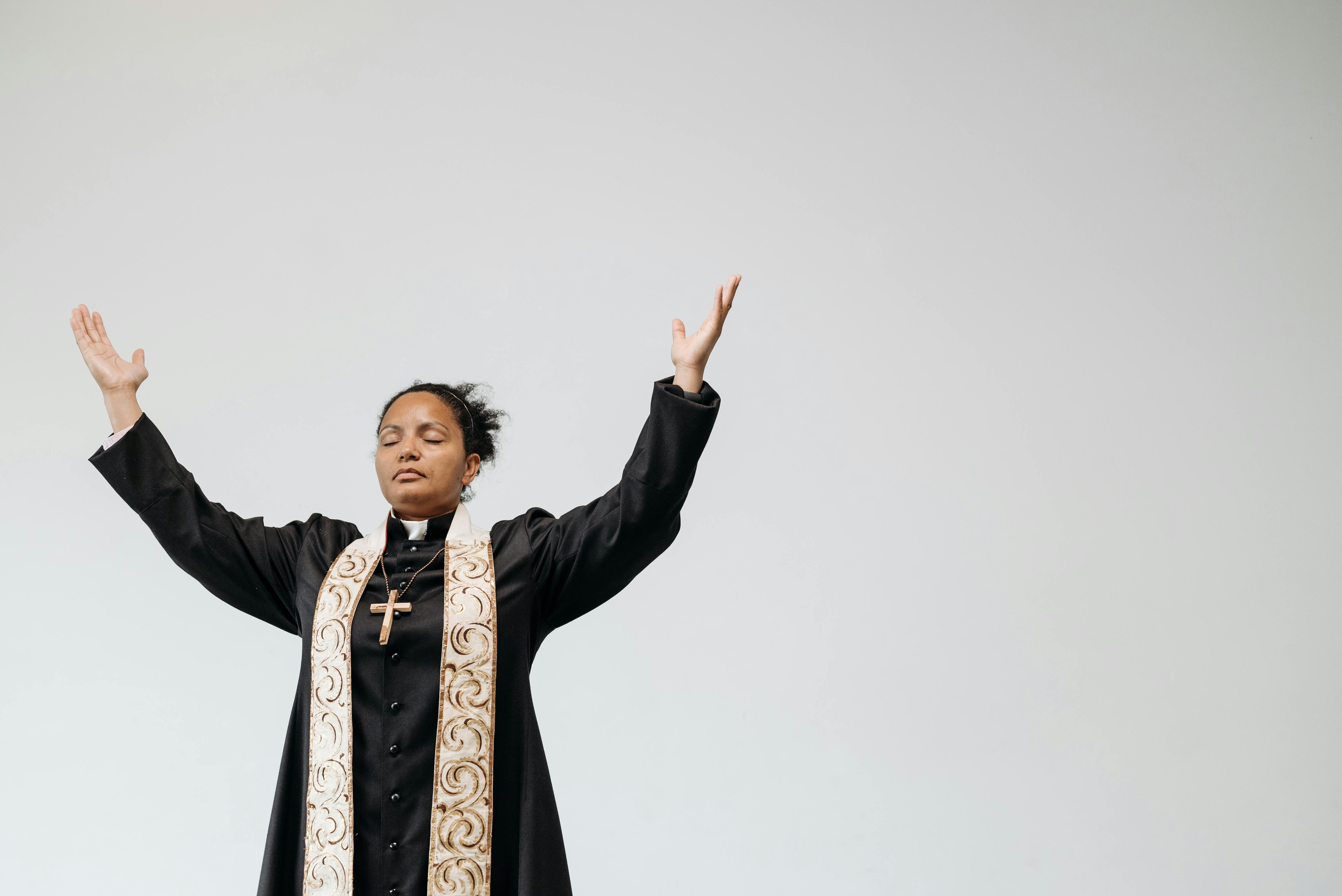 Woman Priest Standing with Raised Arms · Free Stock Photo