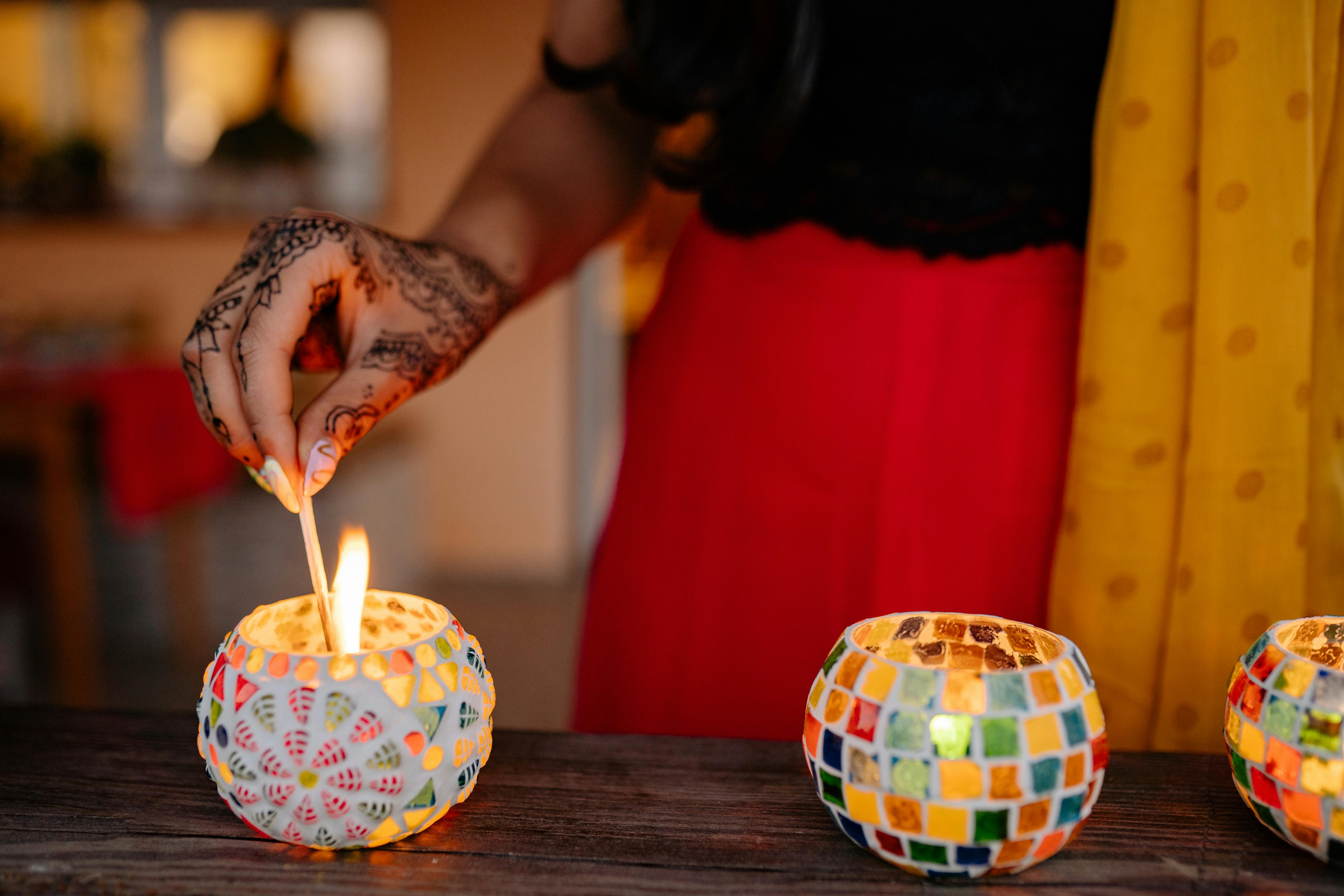 Person Lighting a Candle · Free Stock Photo