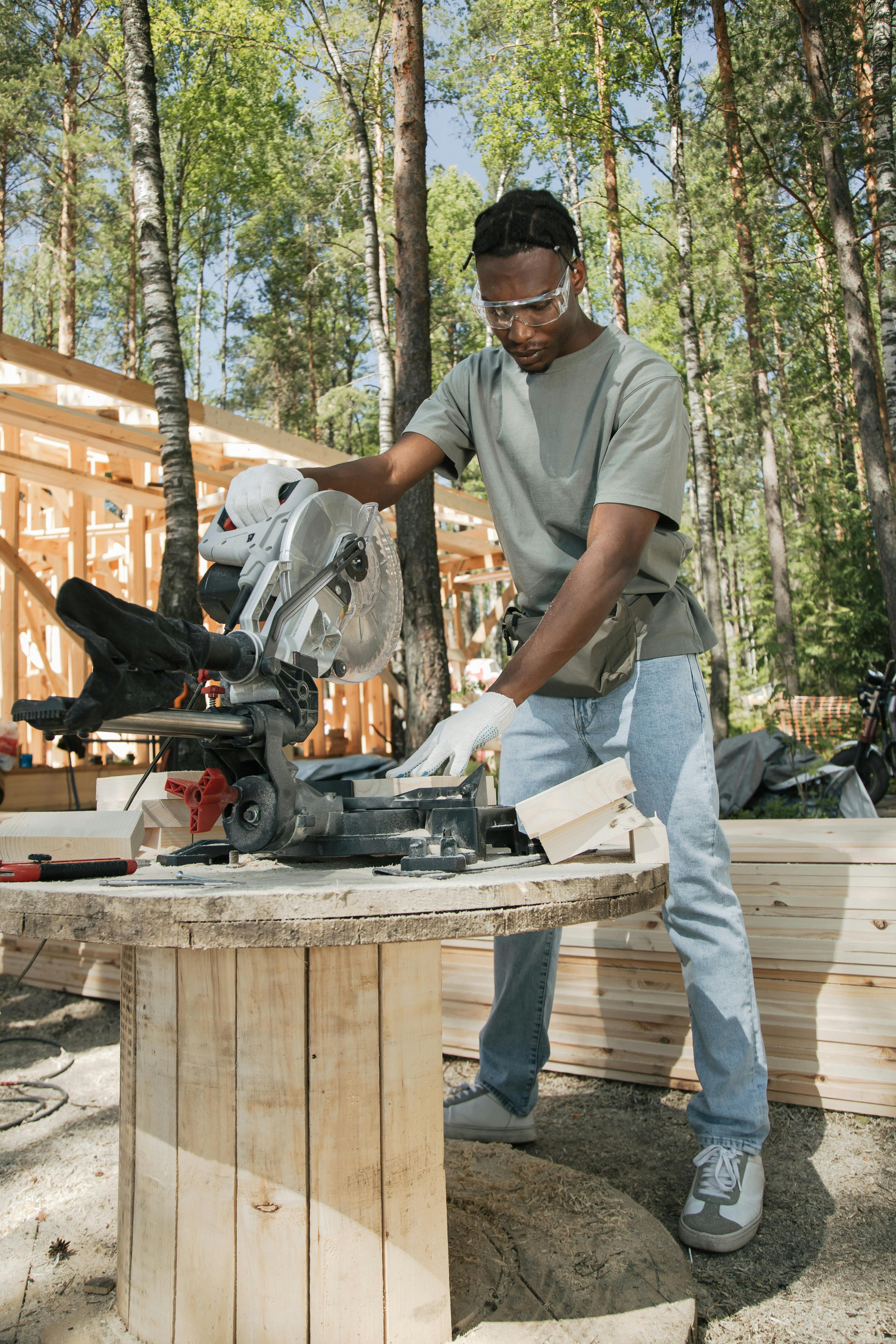 Man Cutting Wood on Saw Machine · Free Stock Photo