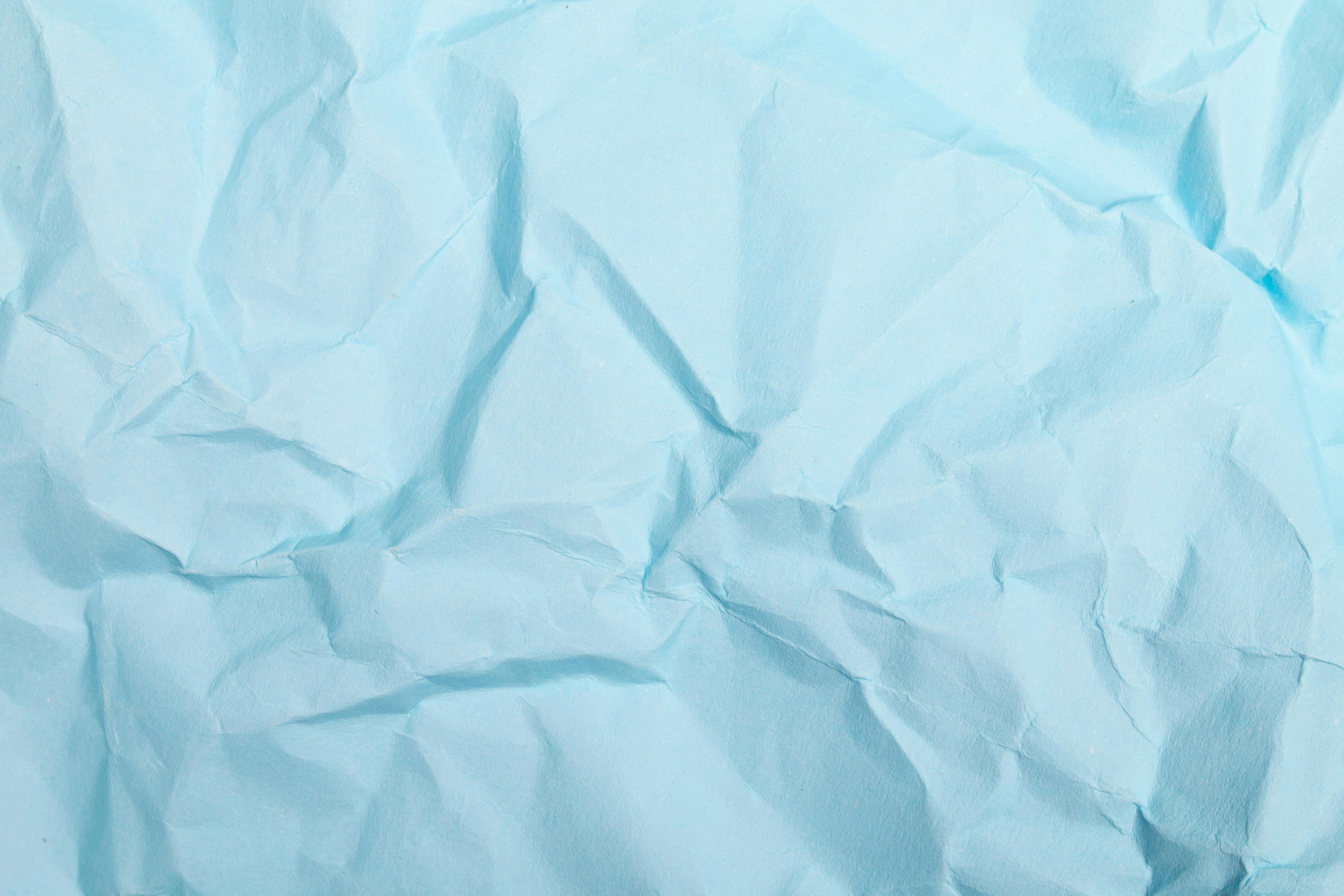 A Close-Up Shot of a Crumpled Blue Paper · Free Stock Photo