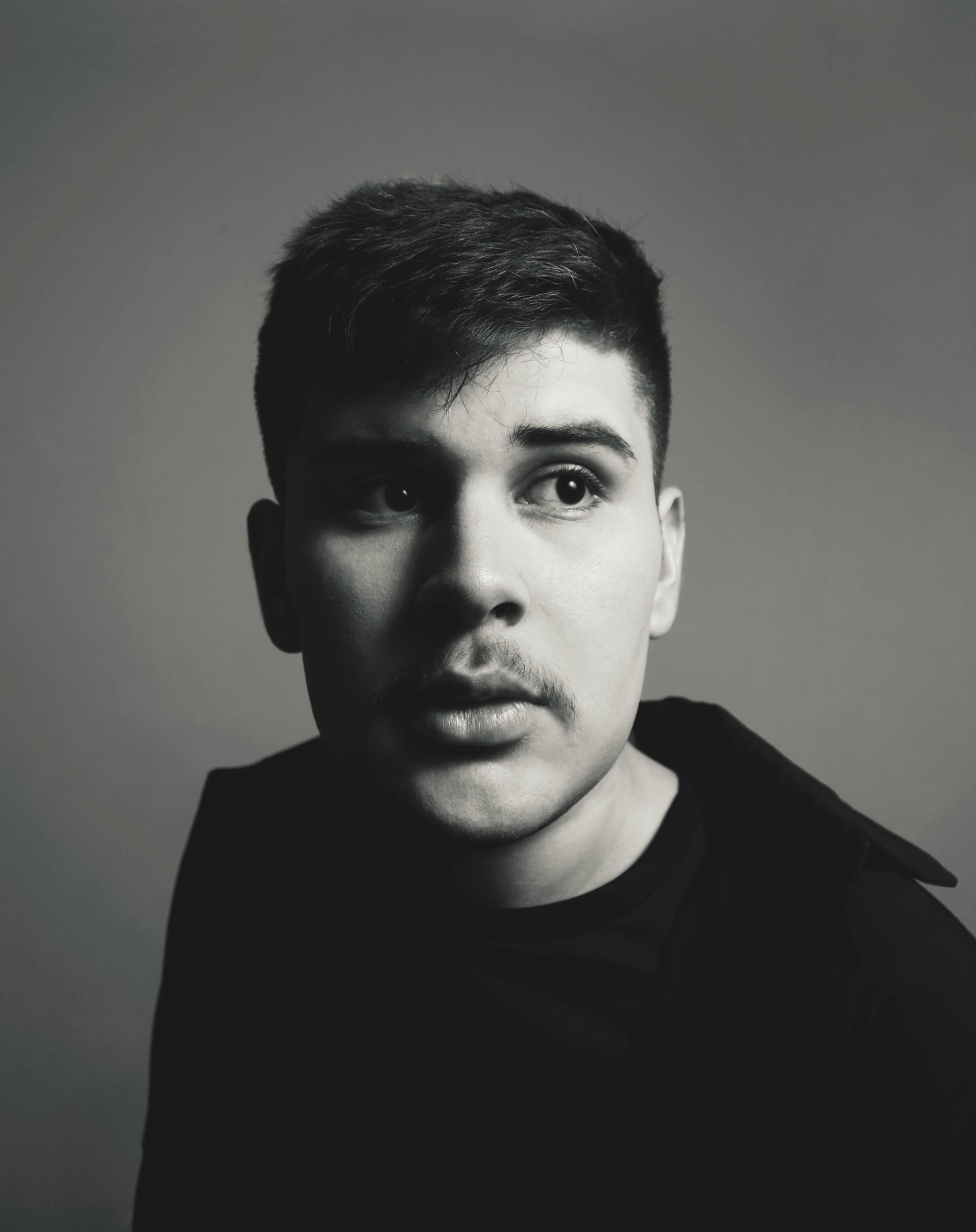 Portrait of a Young Man in a White T-shirt · Free Stock Photo