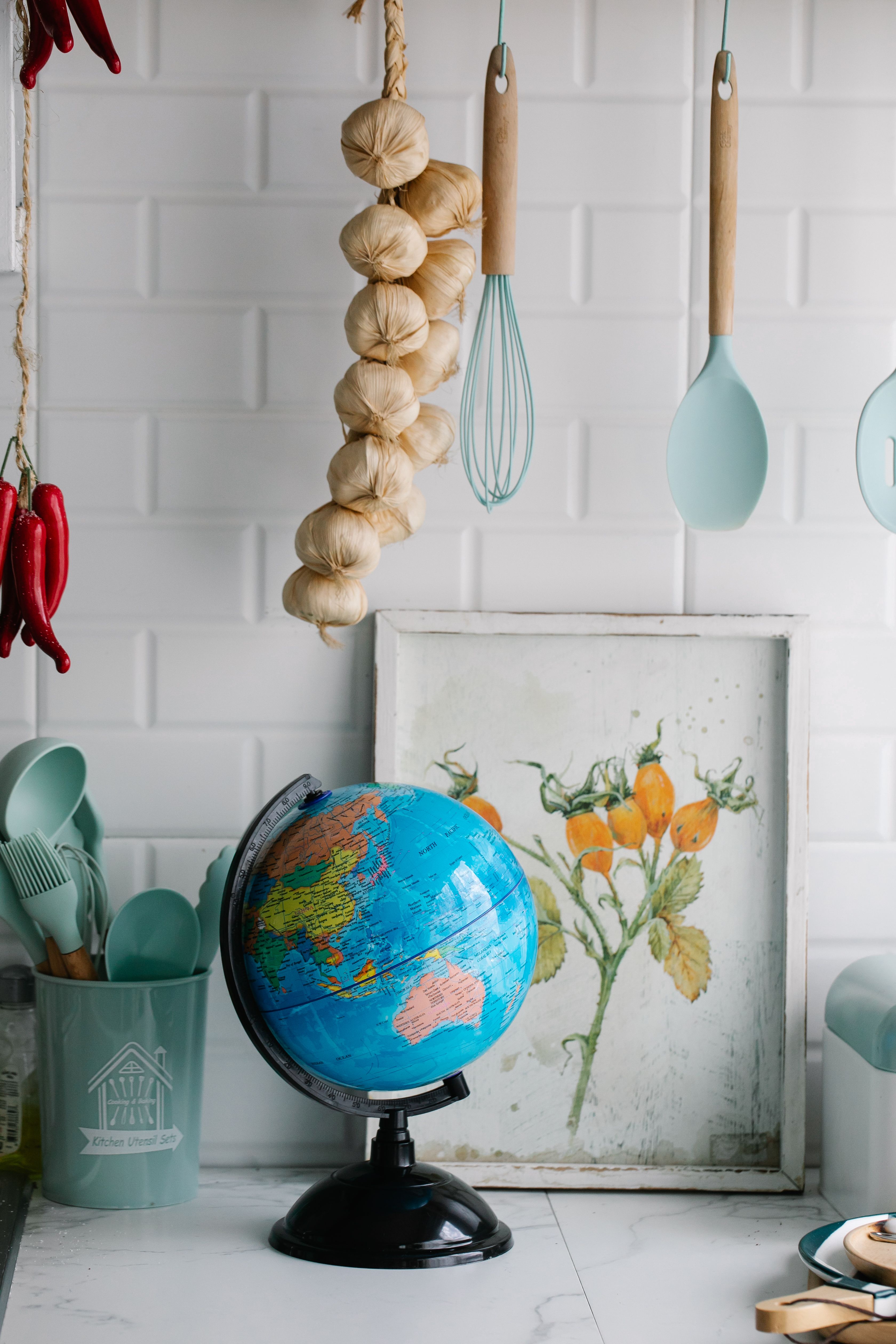 Globe on Table Beside Kitchen Utensils and Frame · Free Stock Photo