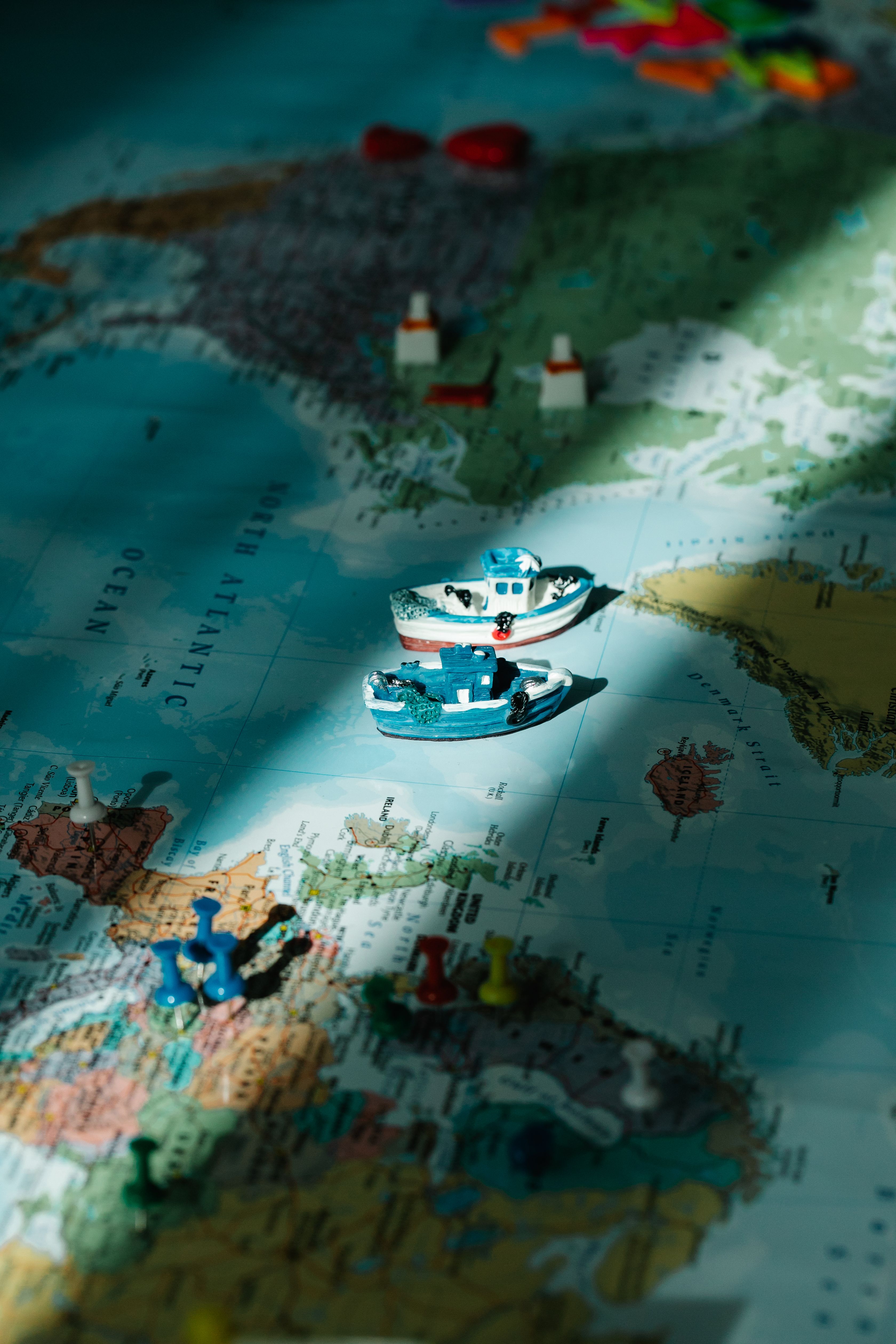 Toy Boats on World Map Illuminated by Sunbeam · Free Stock Photo