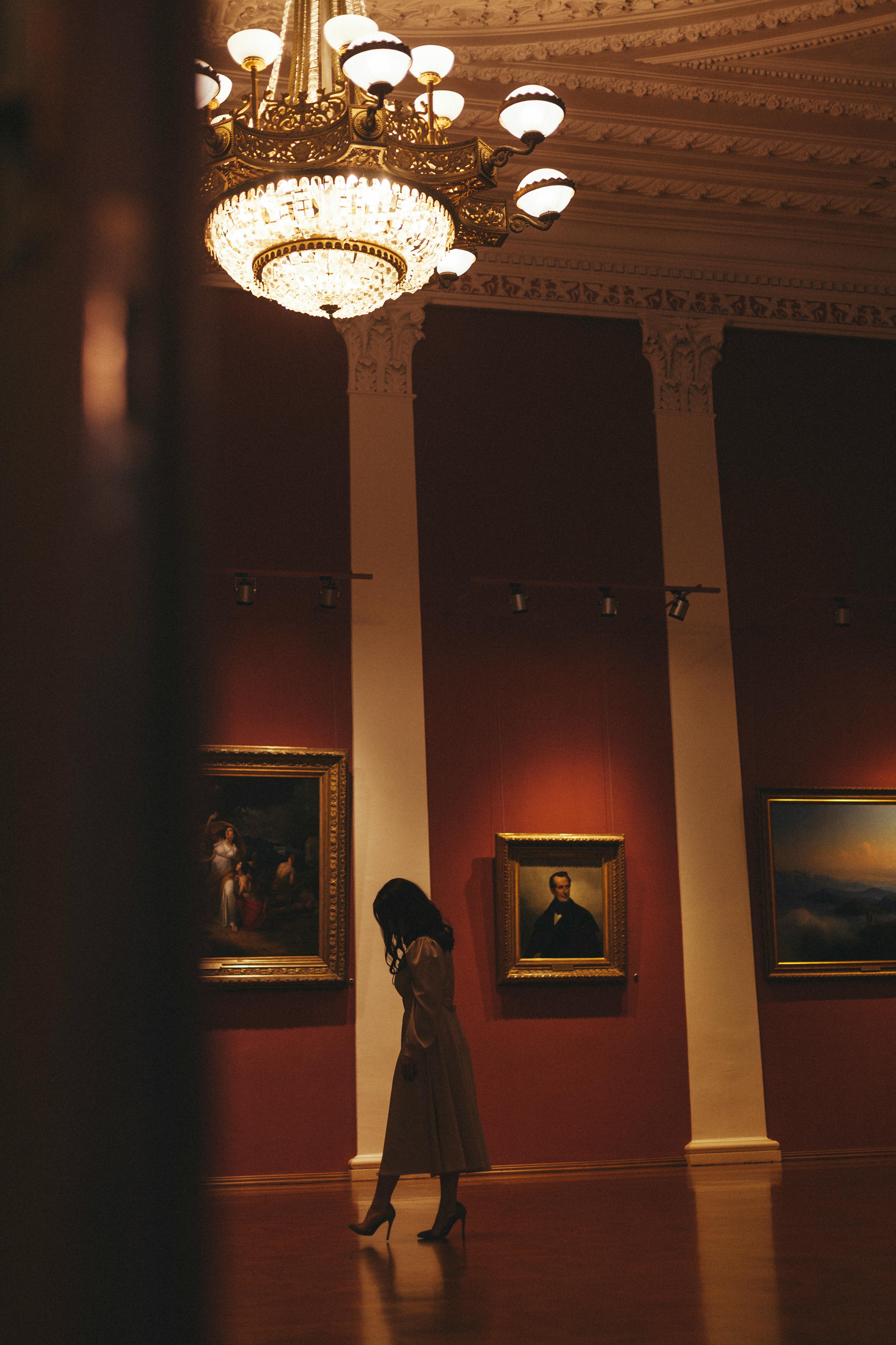 Woman Walking in a Museum · Free Stock Photo