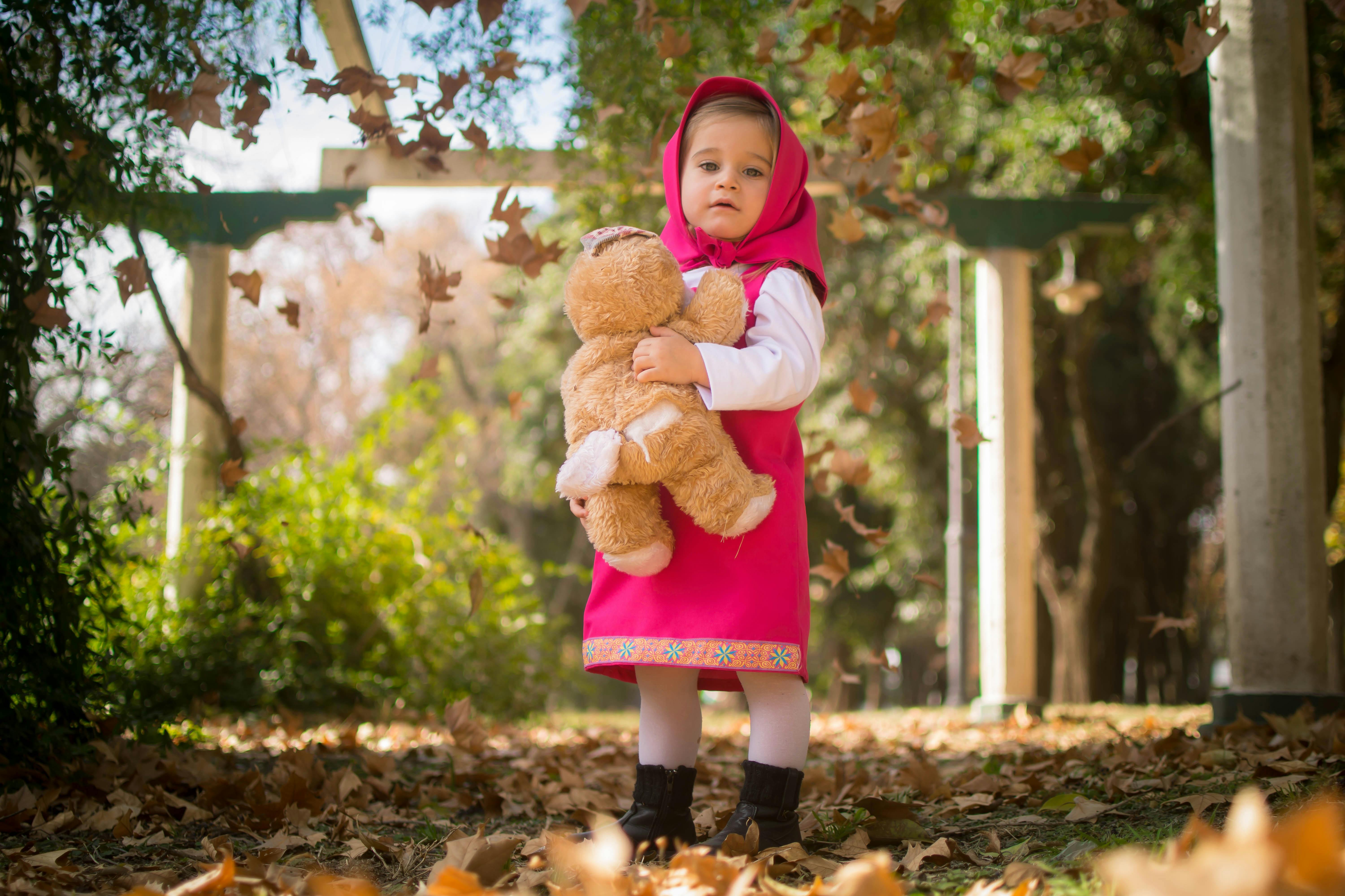A Little Girl Carrying a Stuffed Toy · Free Stock Photo