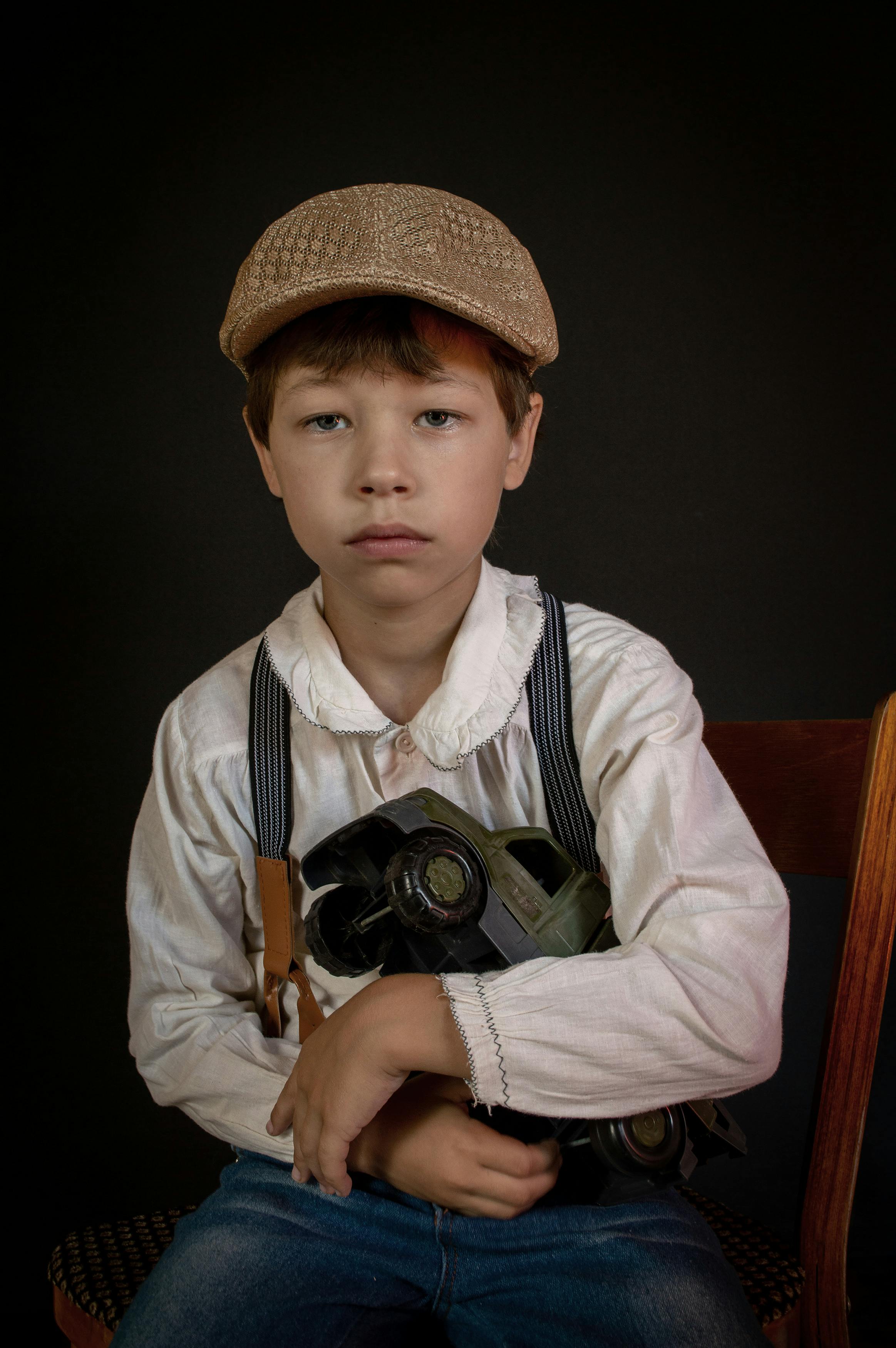 Cute Boy Sitting on a Chair · Free Stock Photo