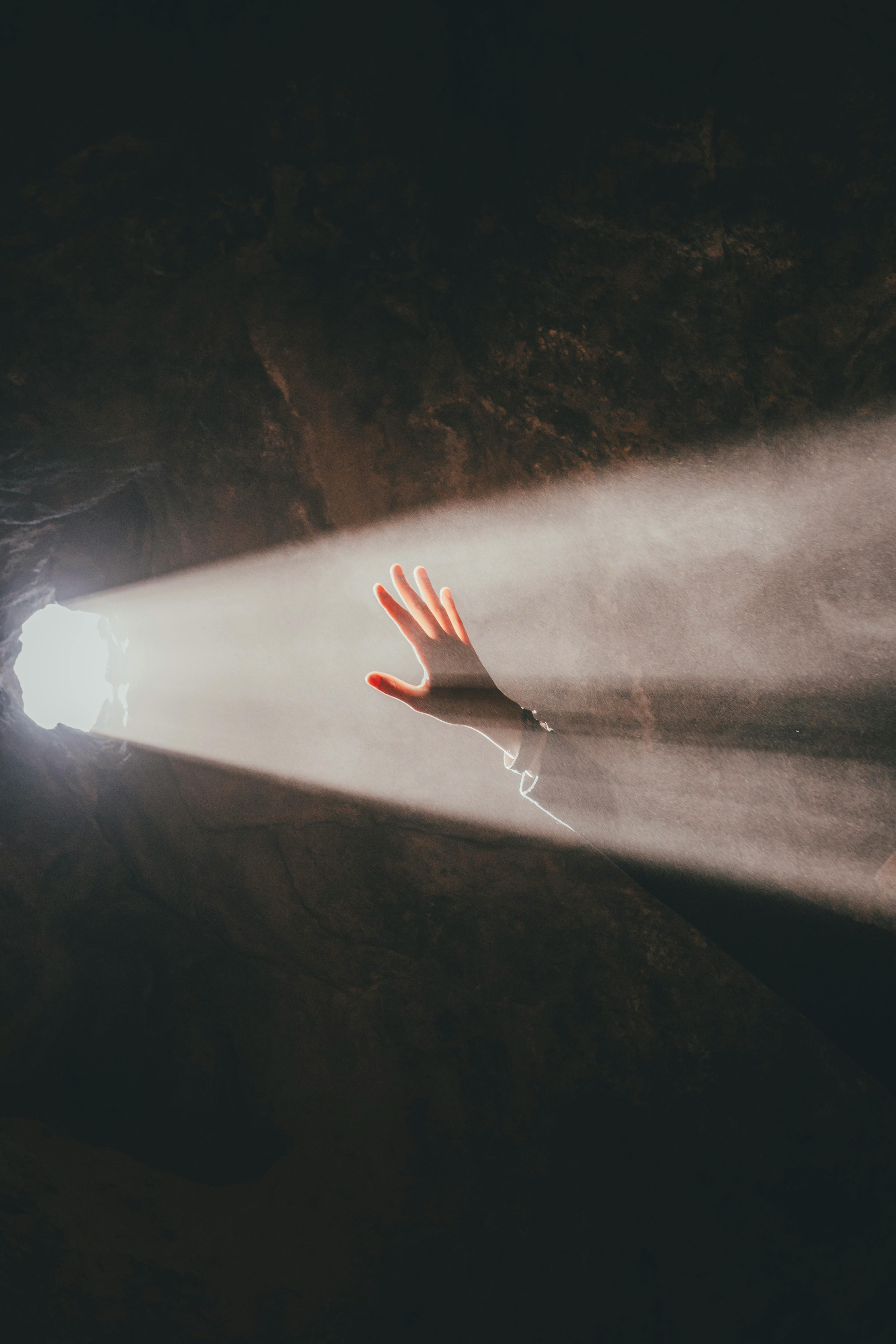 A Hand Near the Hole of a Cave · Free Stock Photo