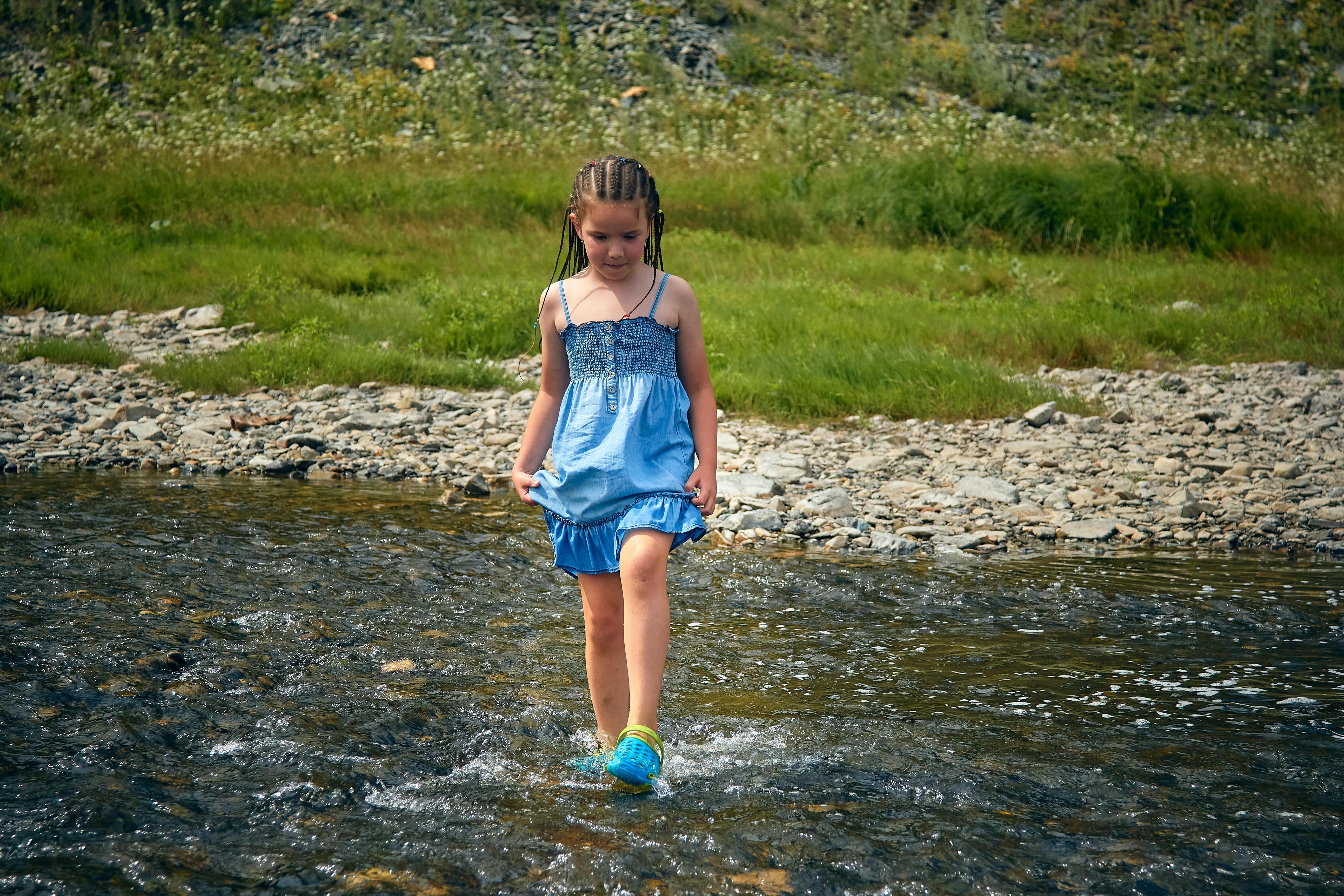 Girl Crossing a Stream · Free Stock Photo