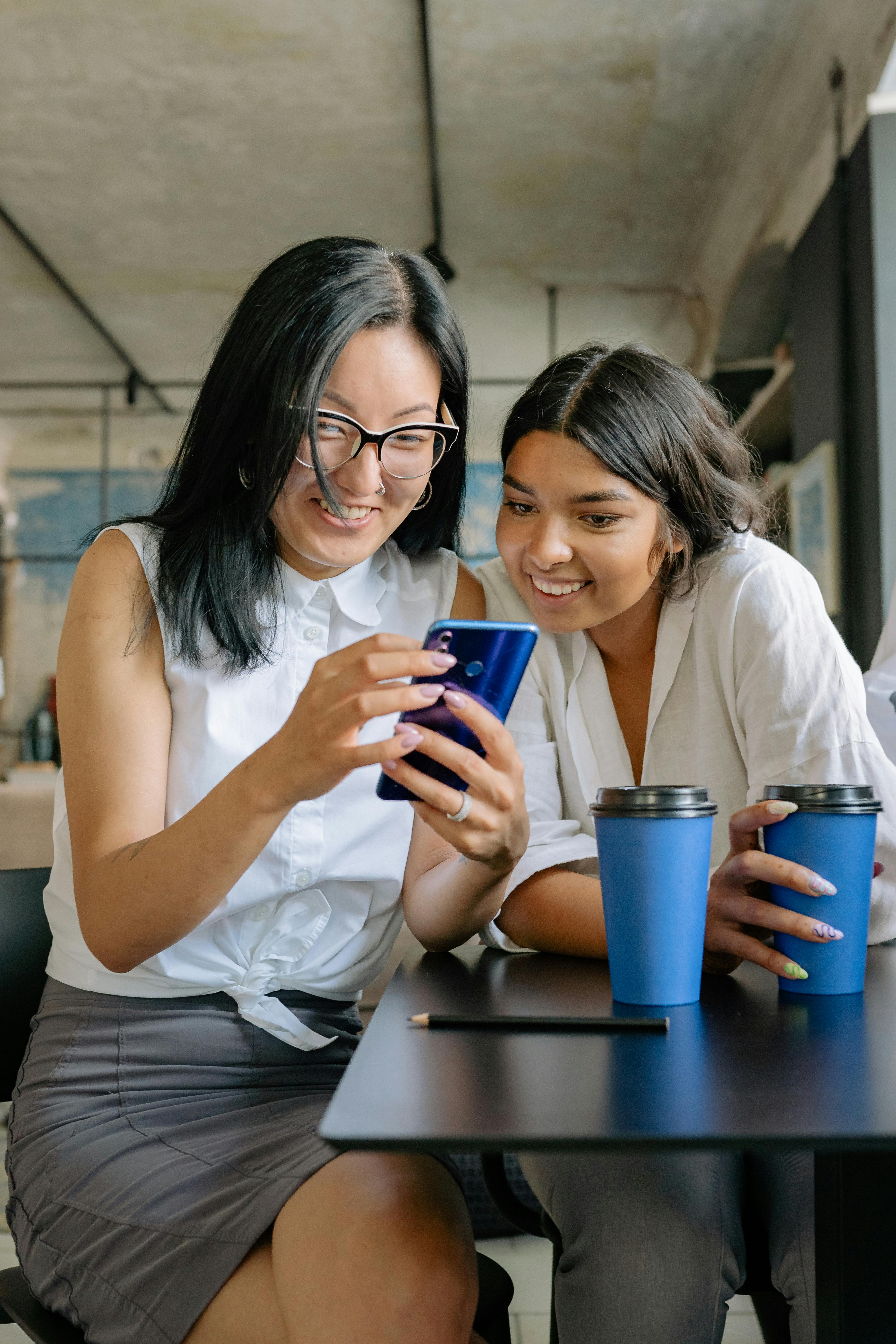 Women Looking at the Screen of a Cellphone · Free Stock Photo