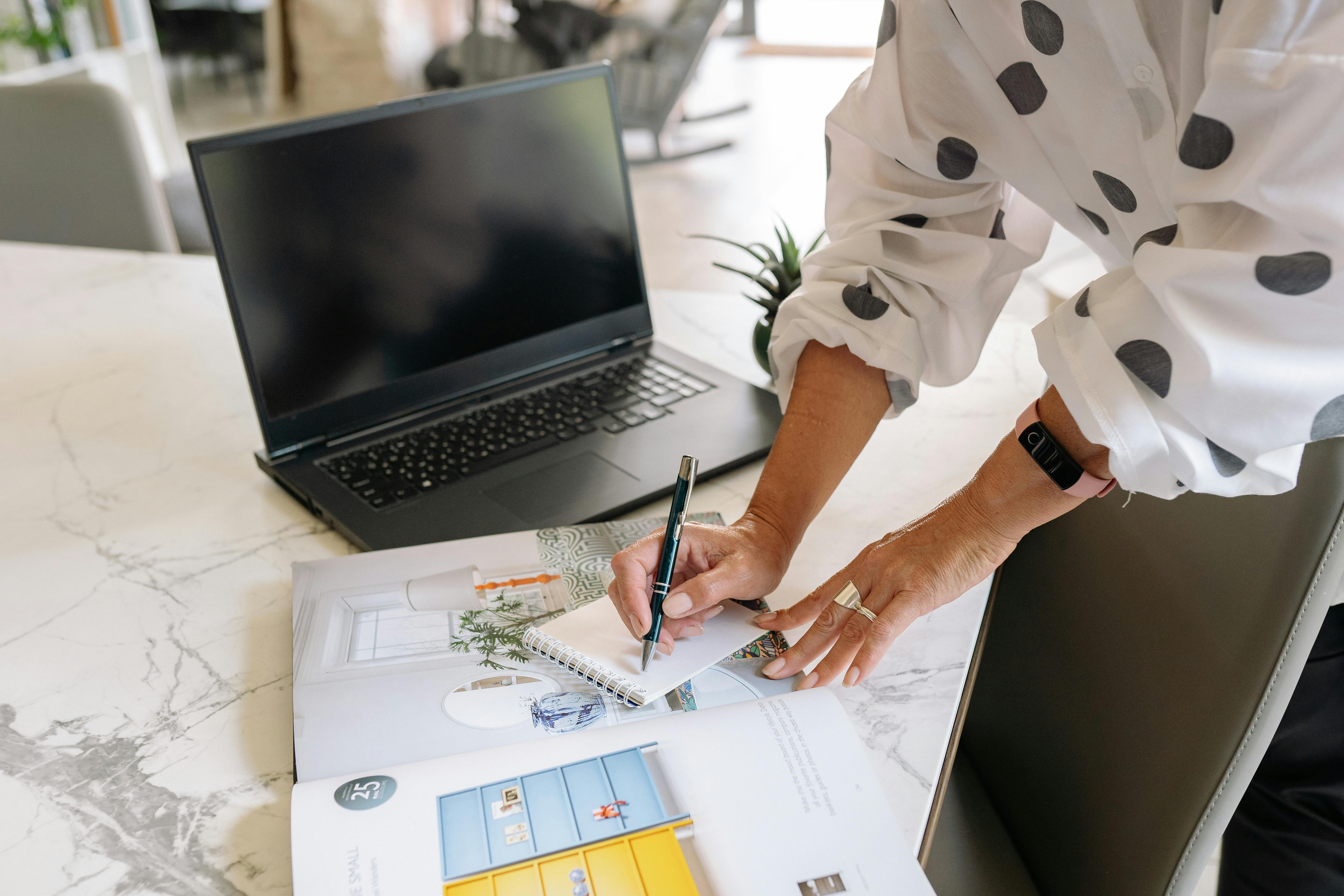 Person Writing on Notepad with a Pen · Free Stock Photo