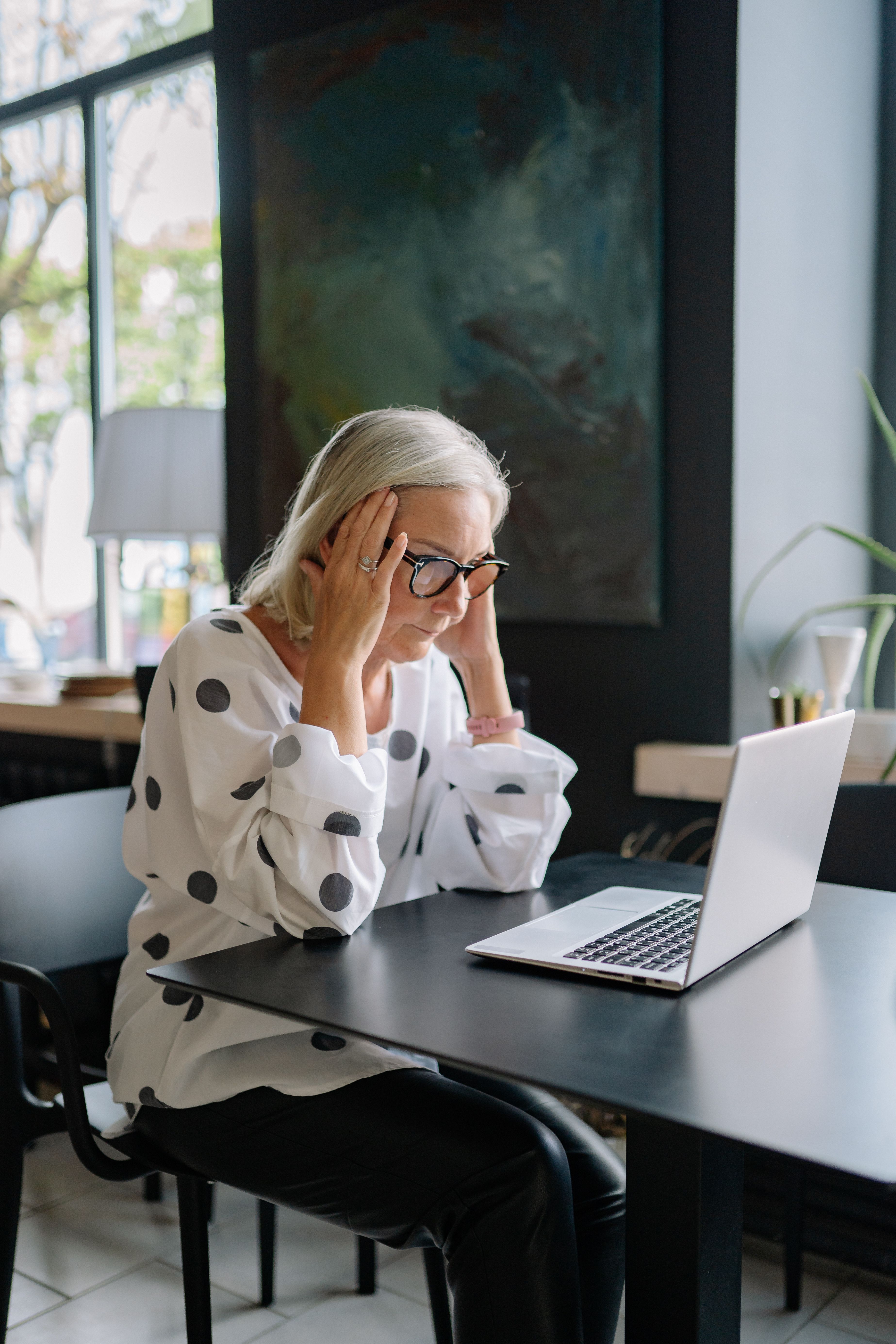 Stressed Woman Using a Laptop · Free Stock Photo
