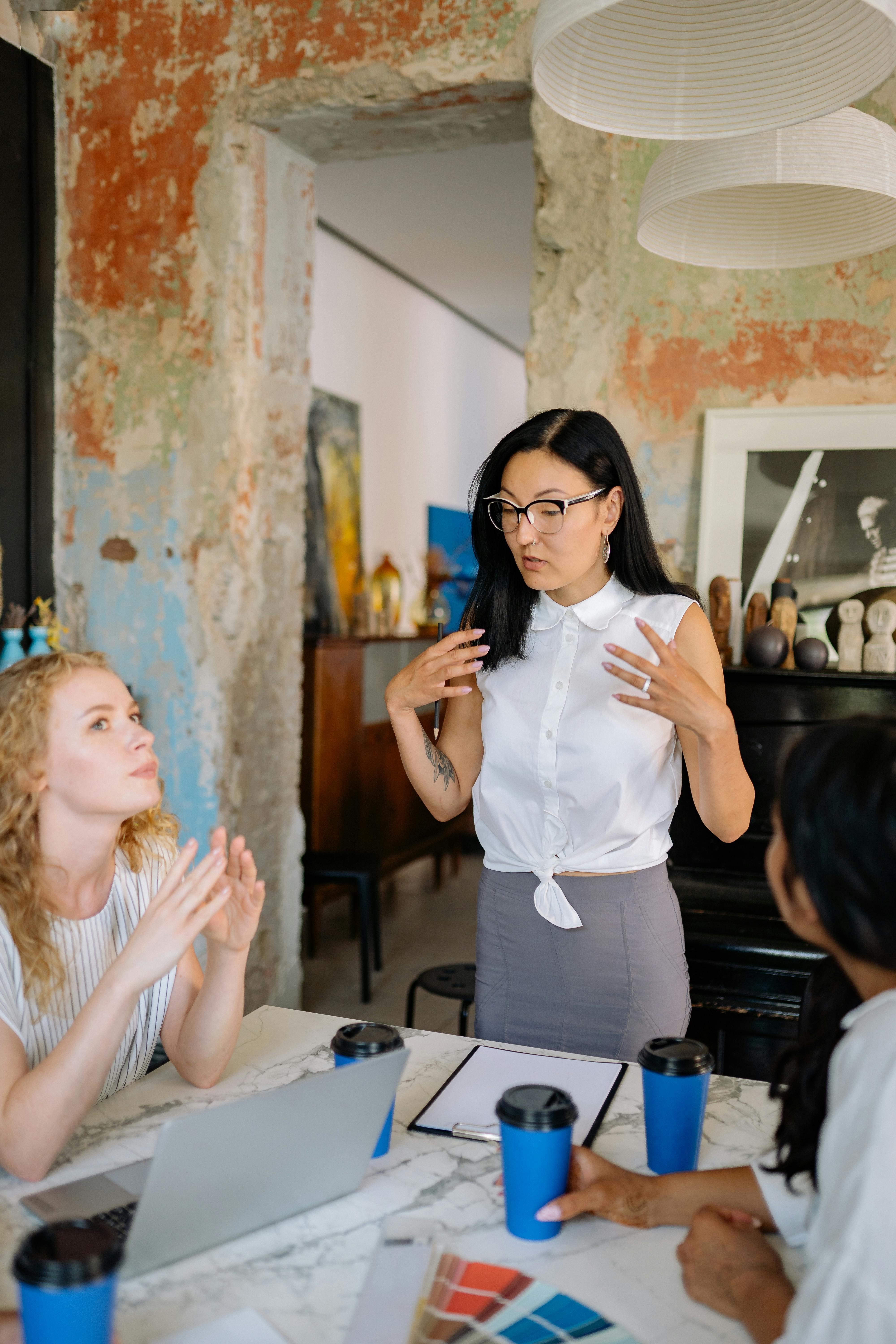 Women Planning While Sitting Near the Gray Haired Woman · Free Stock Photo