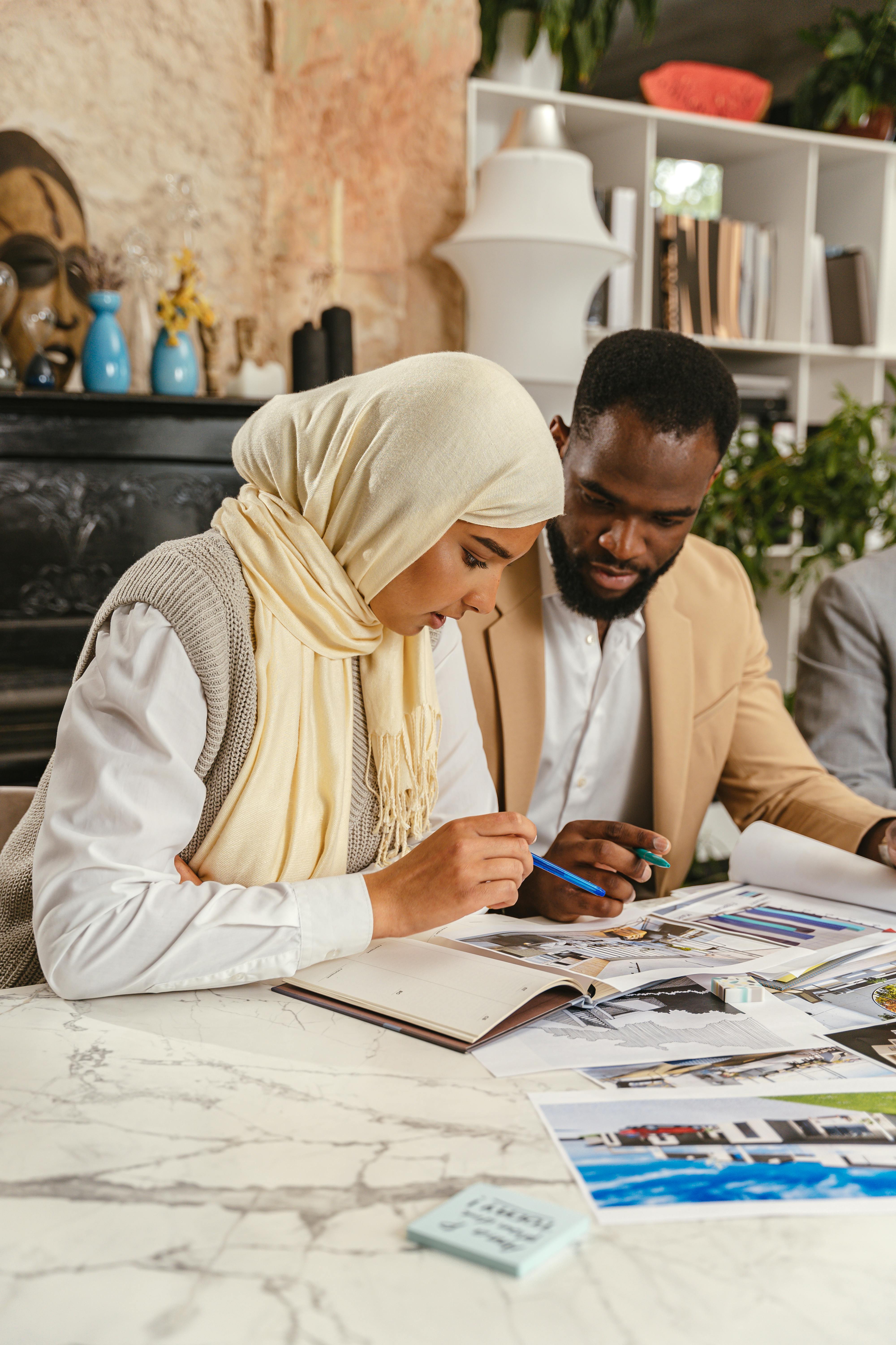 Two People Looking at Illustrations · Free Stock Photo