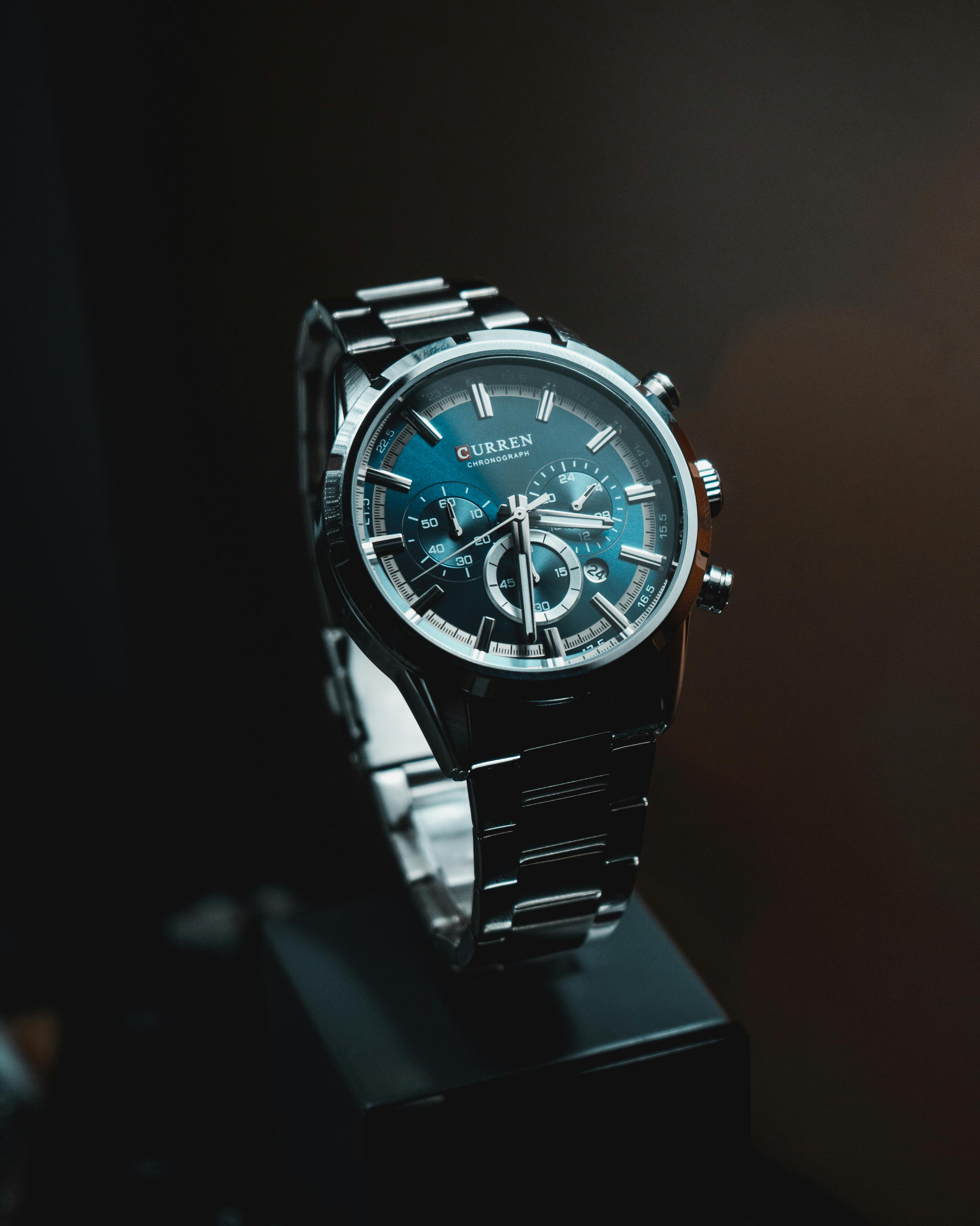Analog Wrist Watch on A Gray Surface · Free Stock Photo