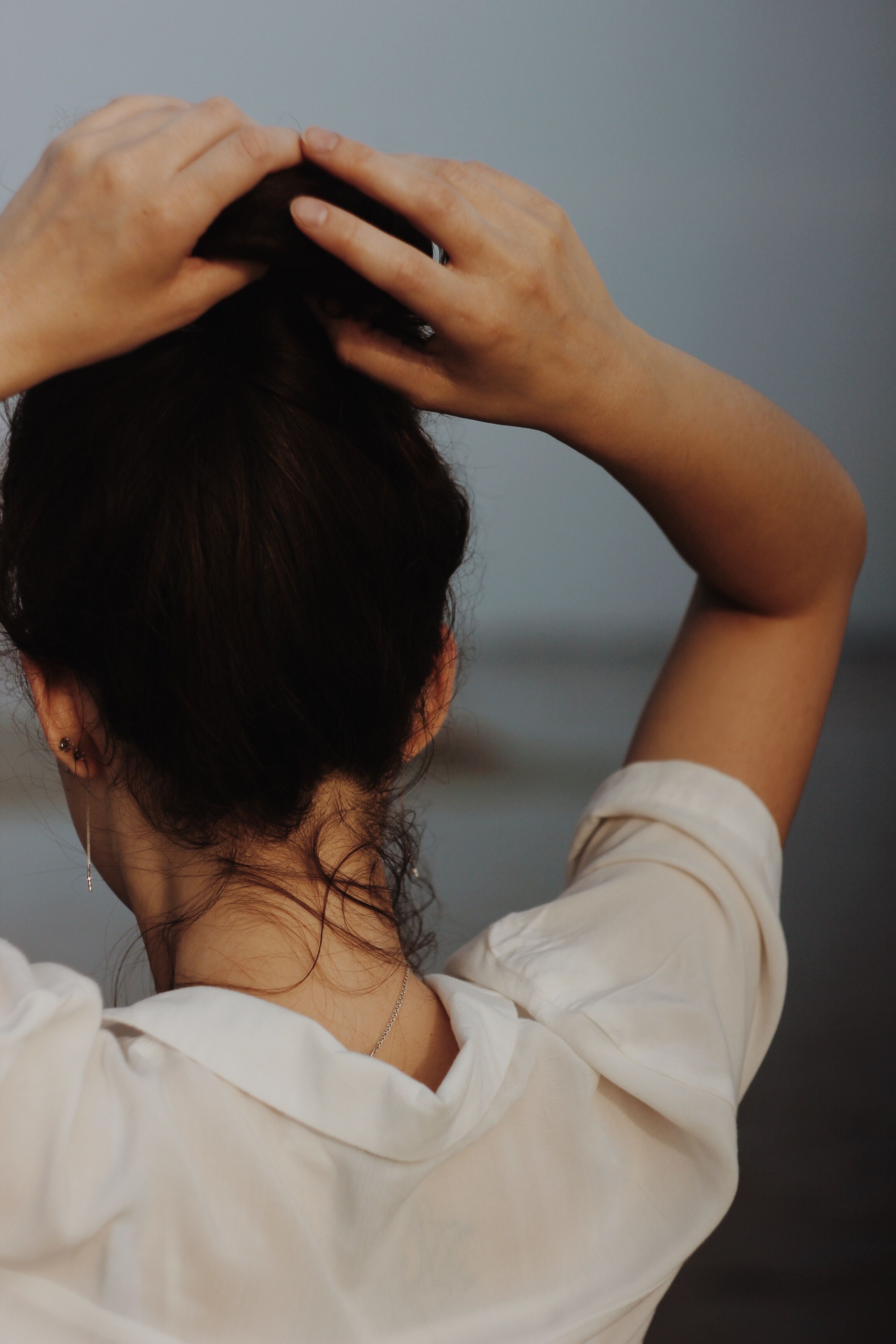 Woman Tying up her Hair · Free Stock Photo