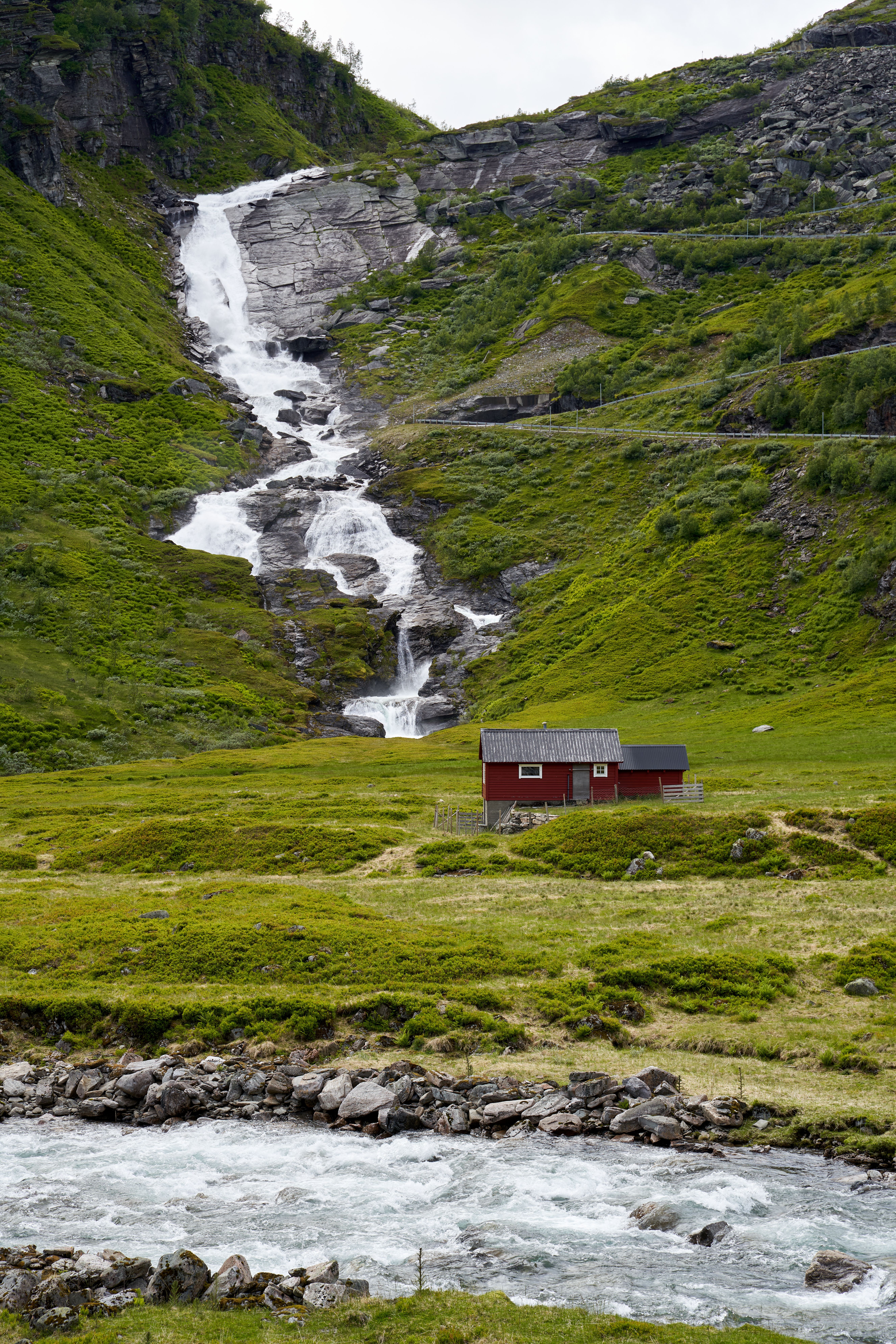 Cottage and Waterfall in a Natural Landscape · Free Stock Photo