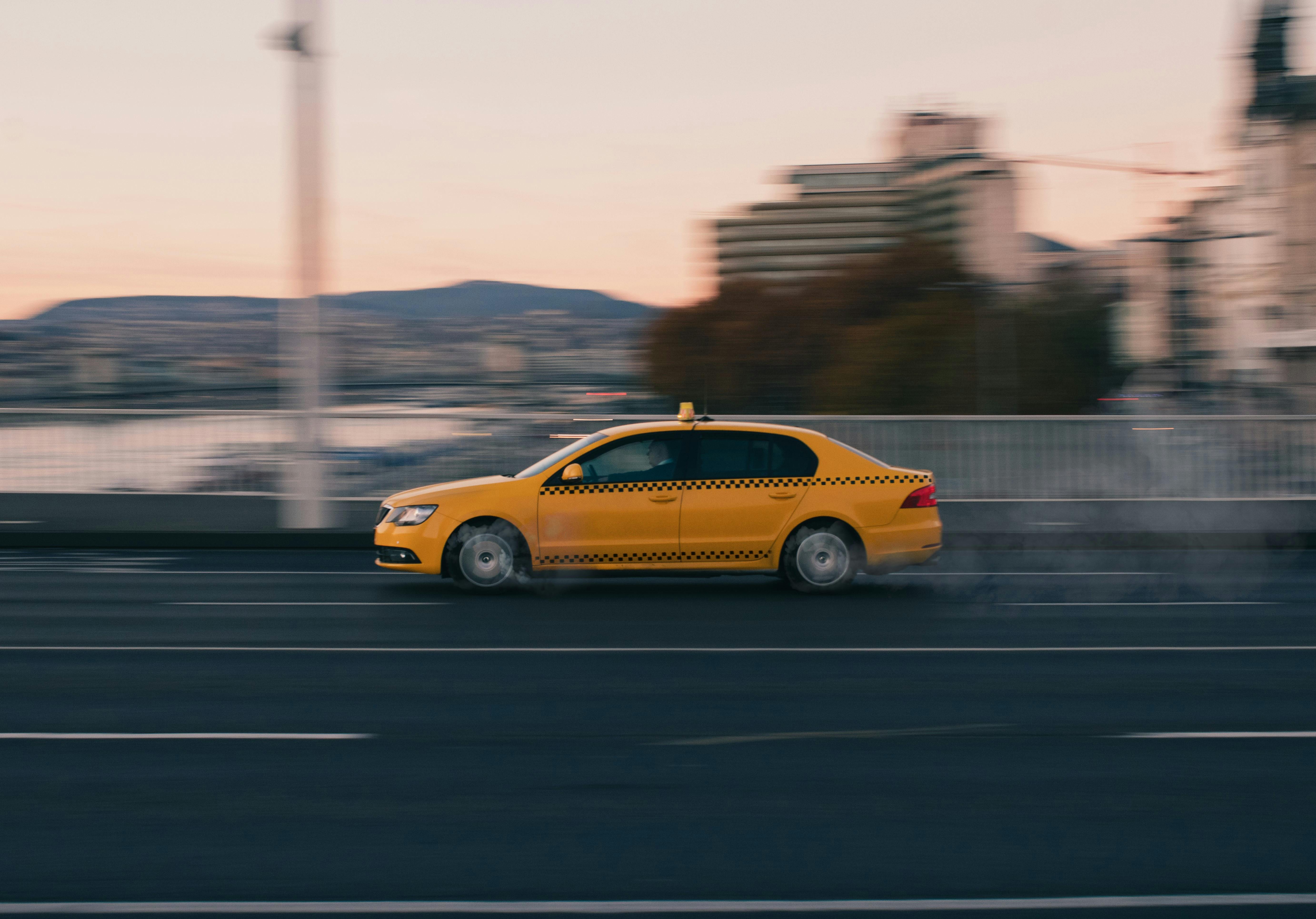 Fast Taxi Driving on Asphalt Road · Free Stock Photo