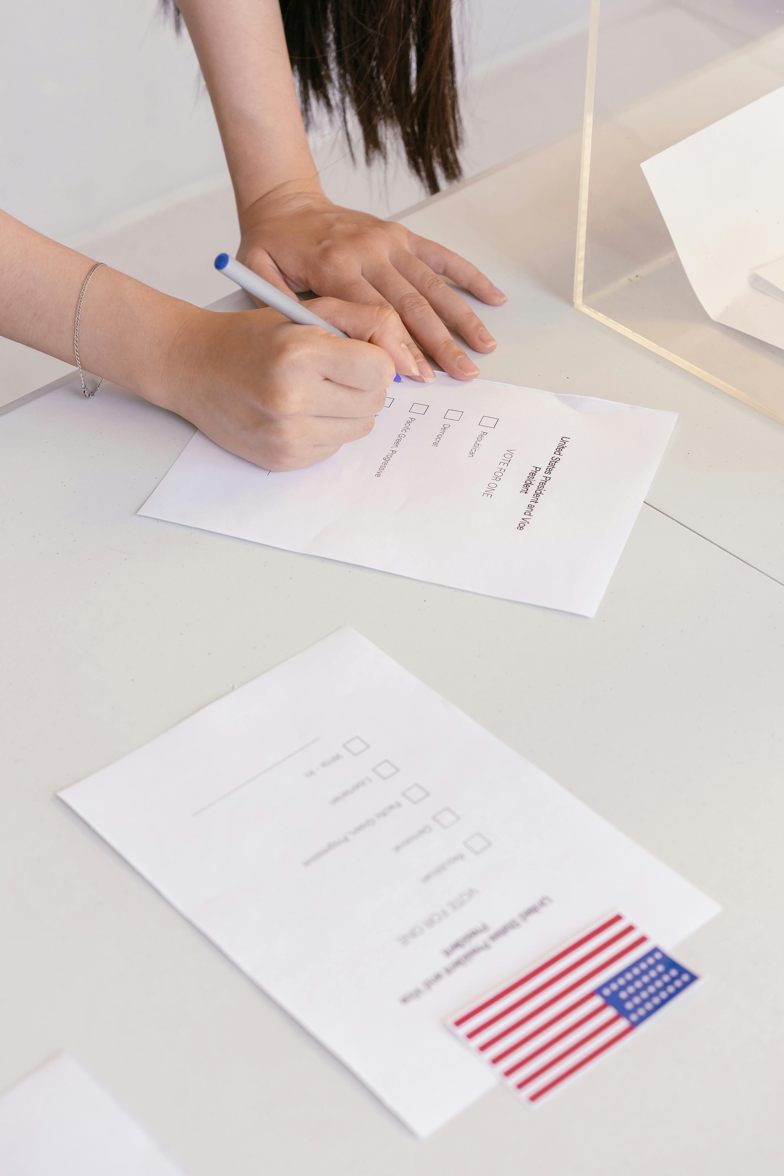 Person Selecting Votes on White Paper · Free Stock Photo