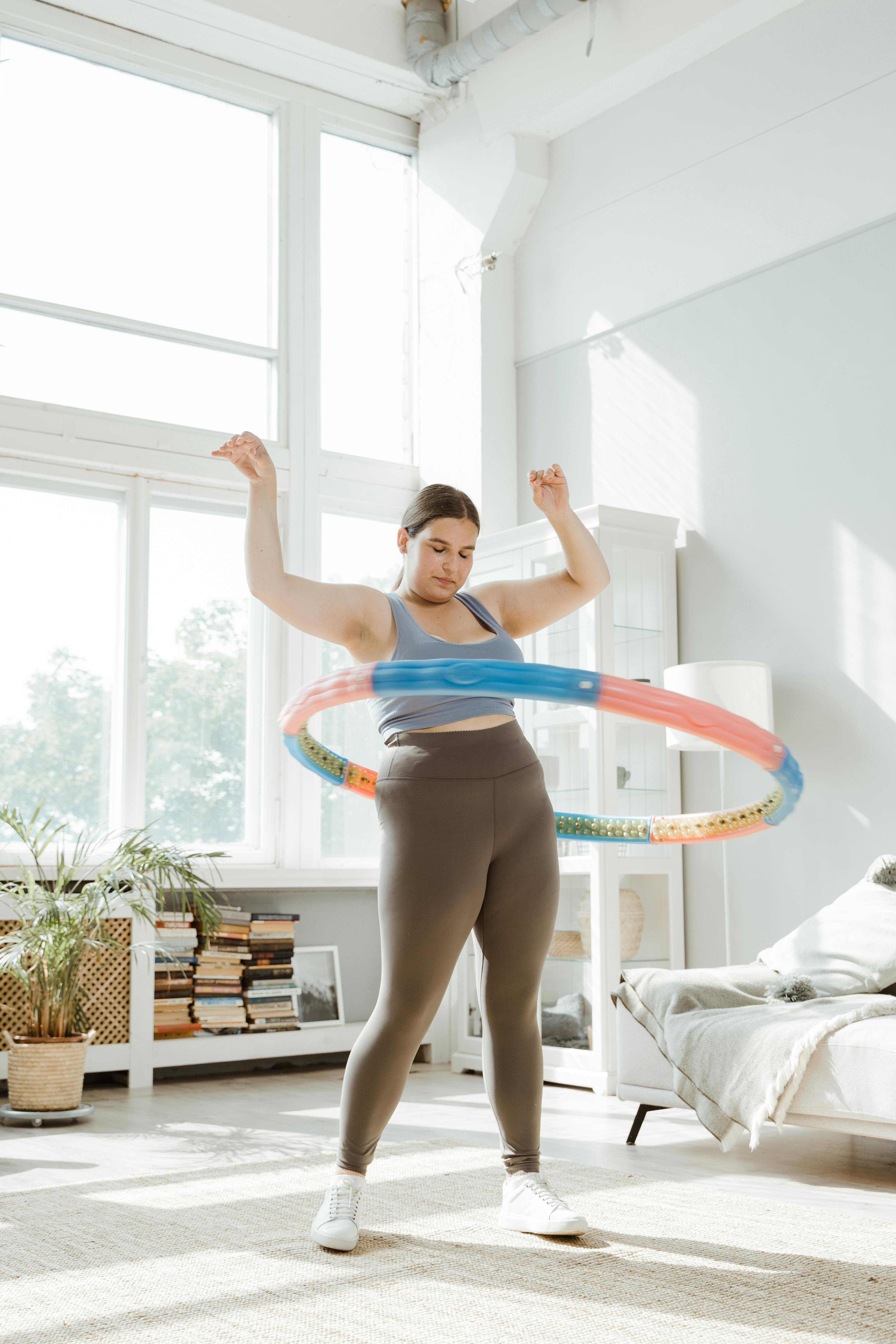 A Woman in Blue Tank Top a Using Hula Hoop · Free Stock Photo