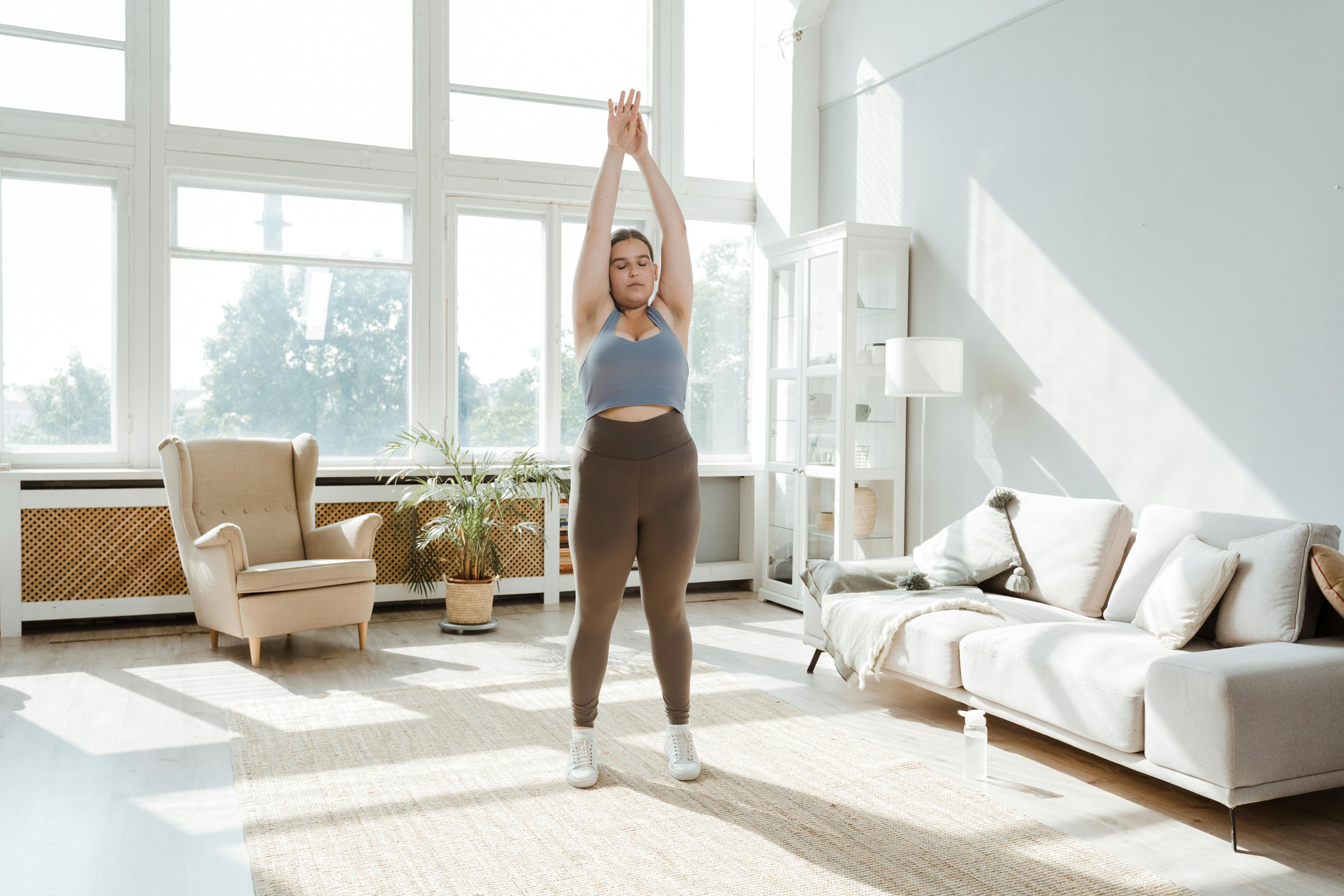 A Woman Stretching Indoors · Free Stock Photo