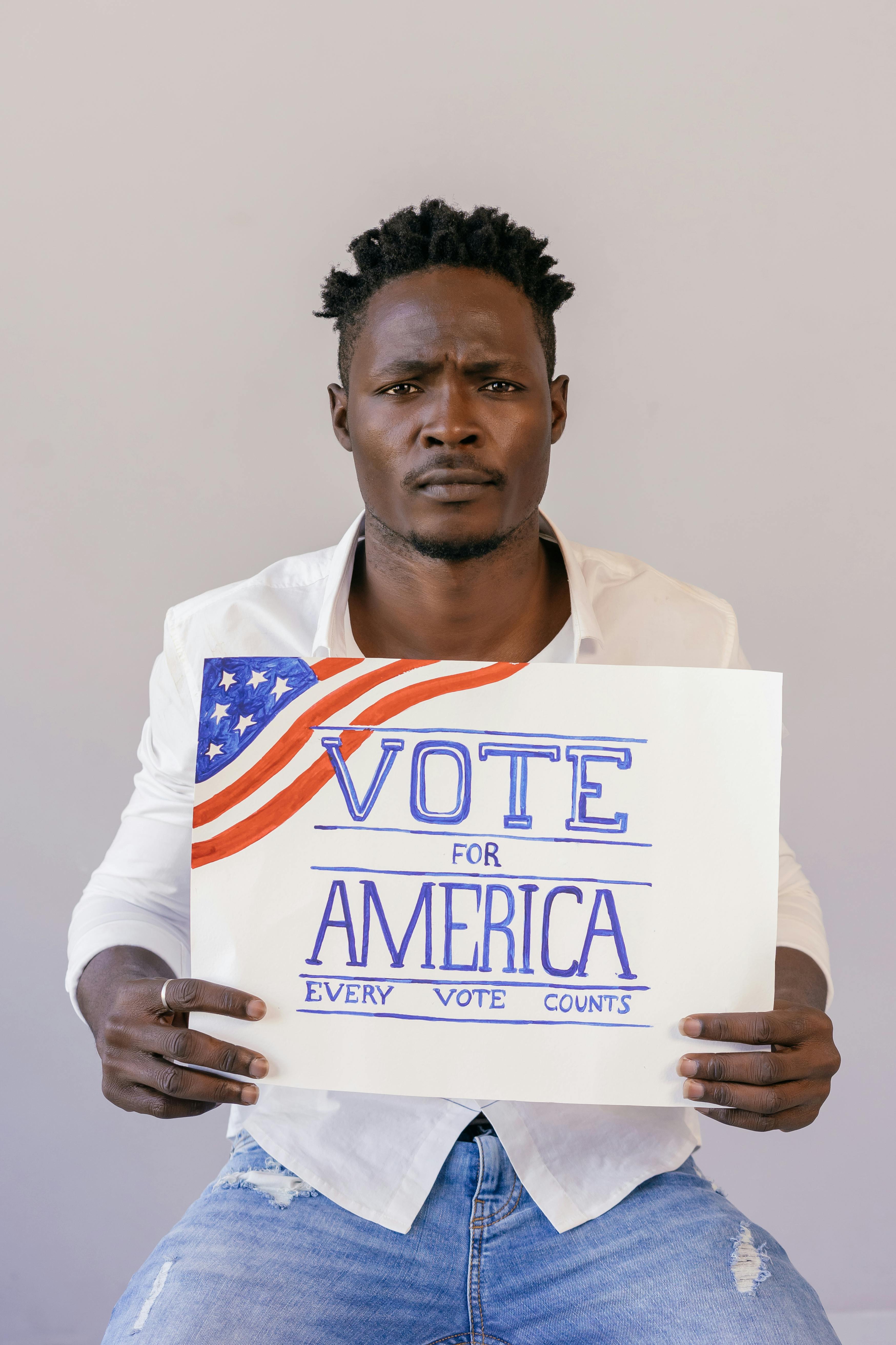 Man Holding a Vote Signage · Free Stock Photo