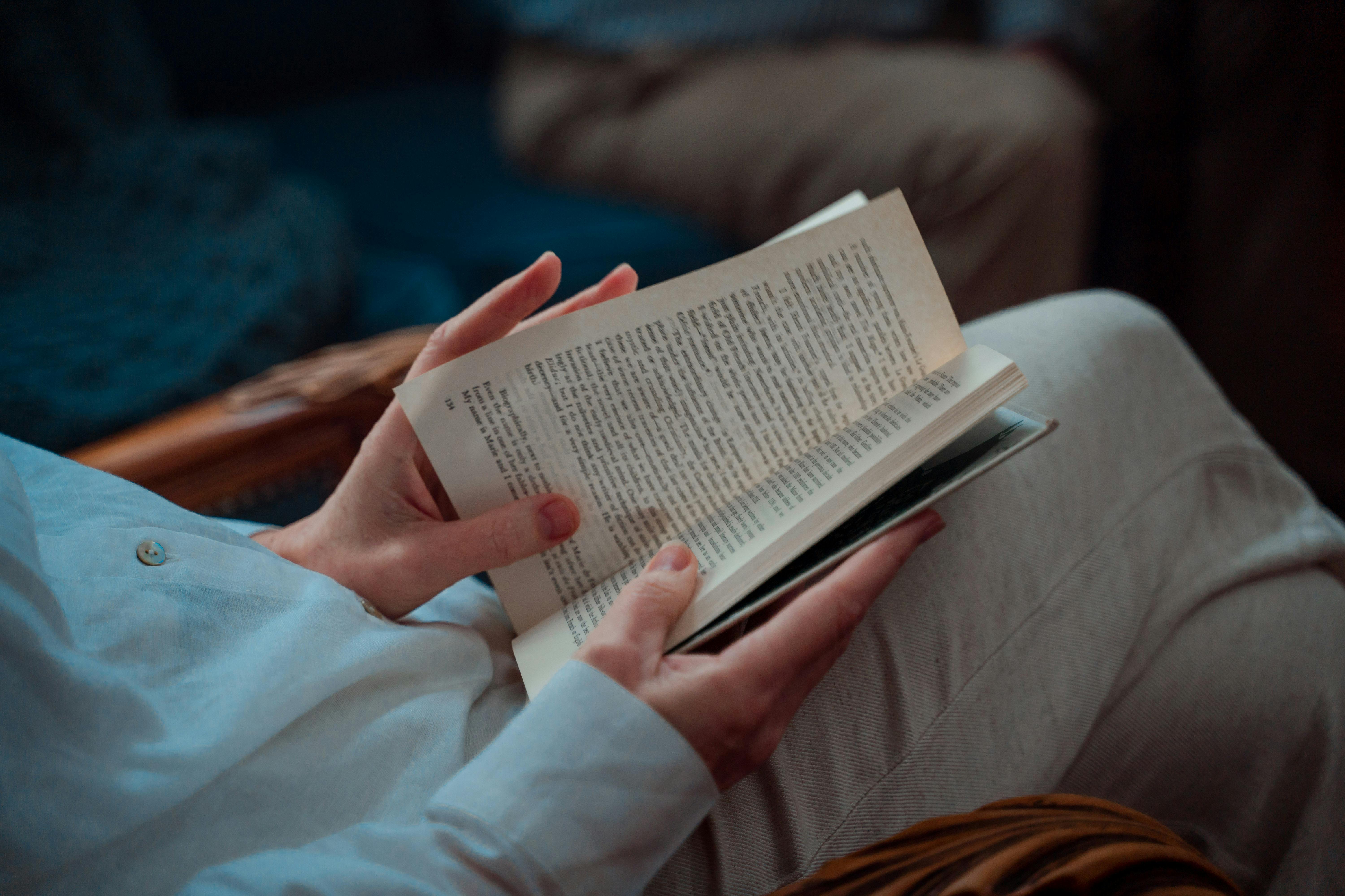 Person Sitting With An Open Book · Free Stock Photo
