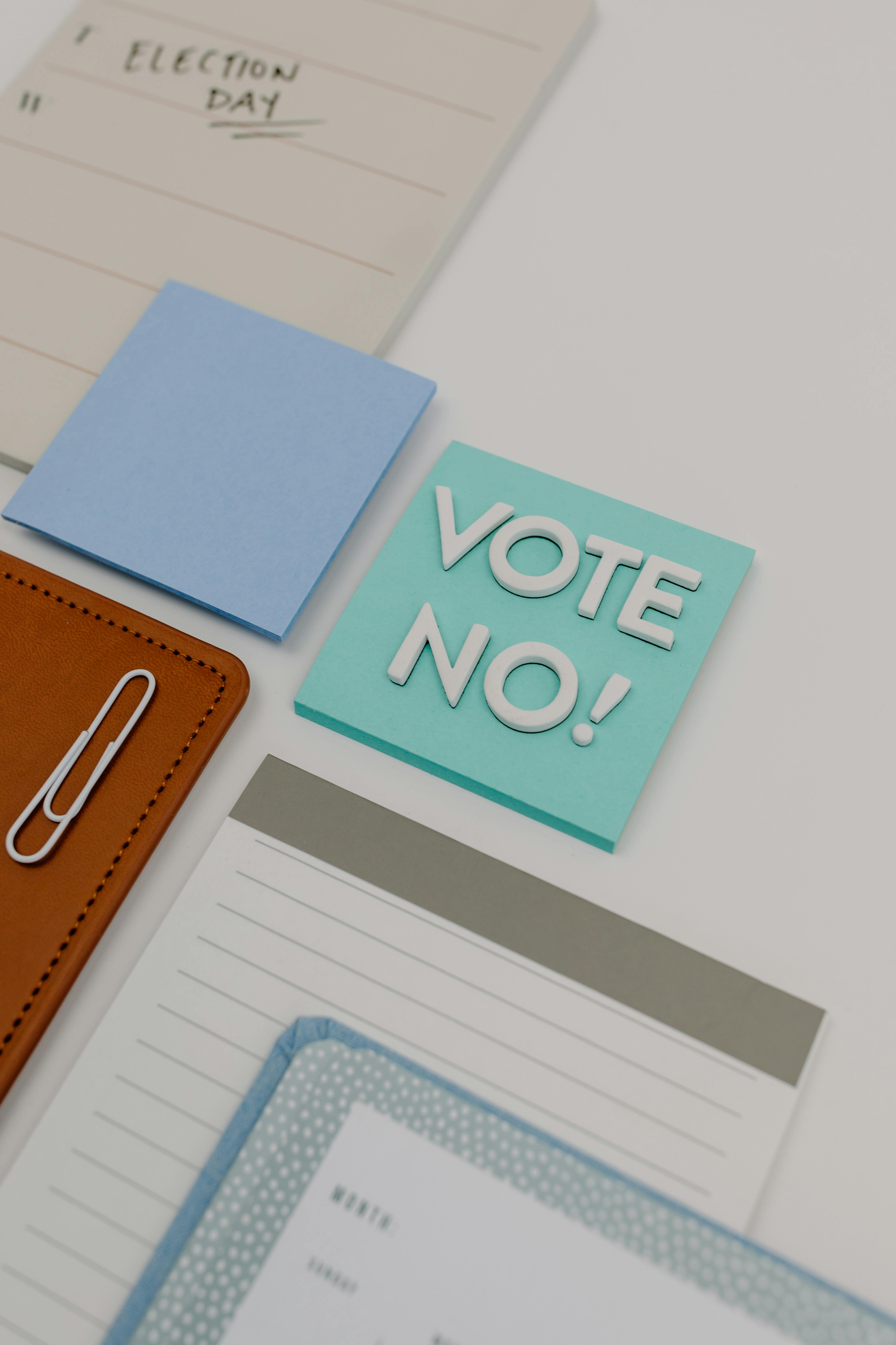 Paper and Notes on a White Surface · Free Stock Photo