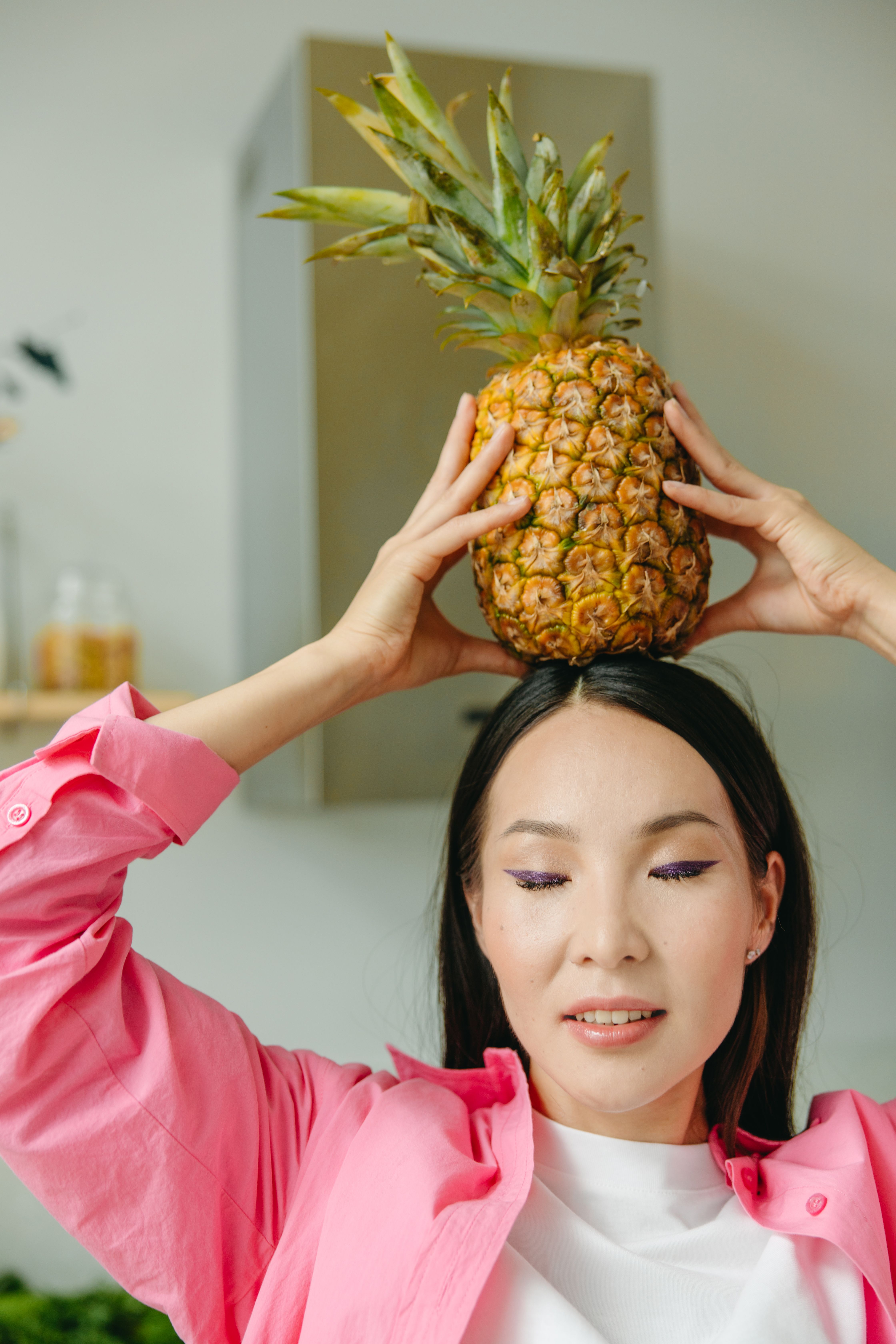 Person in Pink Long Sleeves Holding a Pineapple Fruit · Free Stock Photo