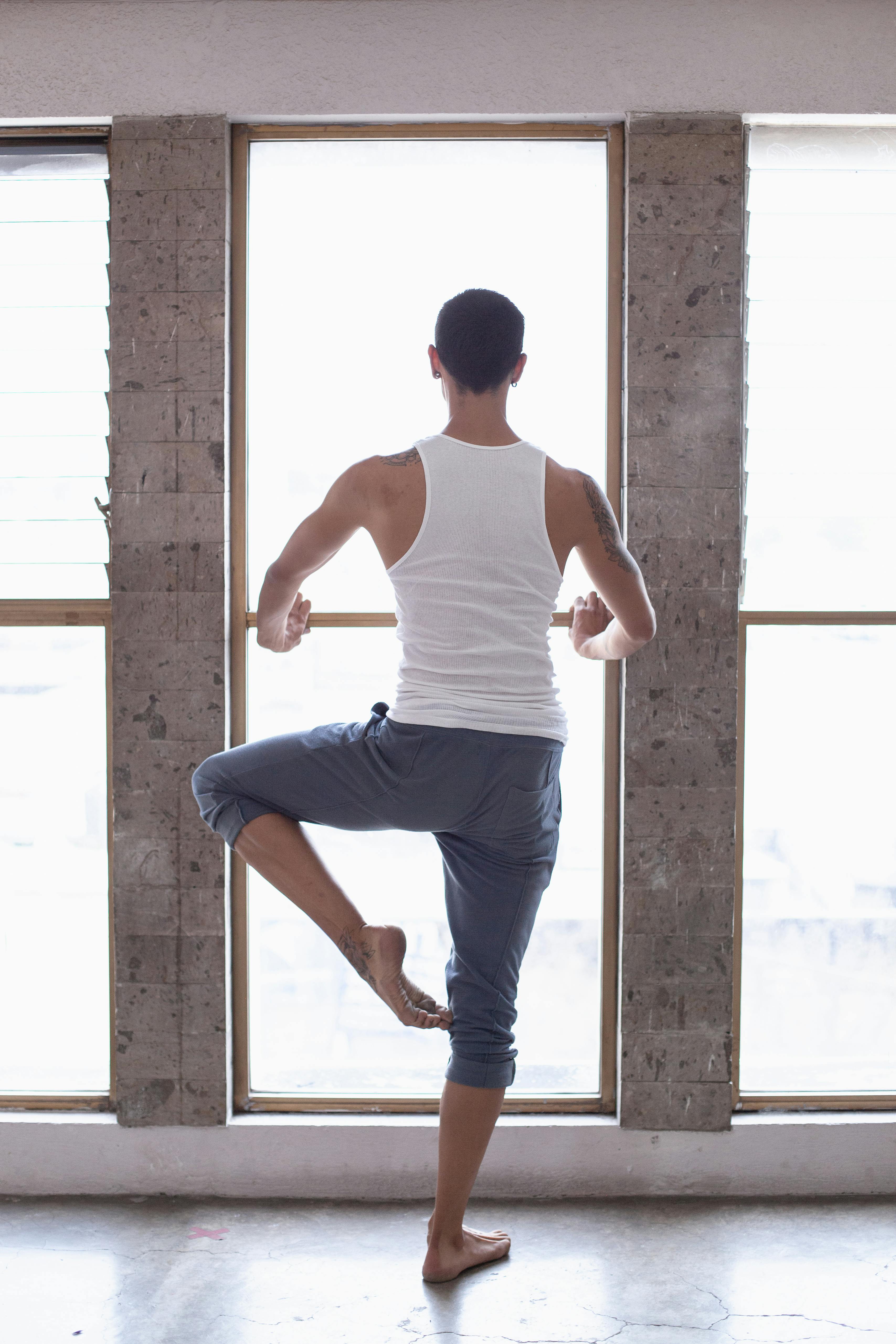 Woman in Black Tank Top and Gray Pants Hugging Brown Textile · Free ...