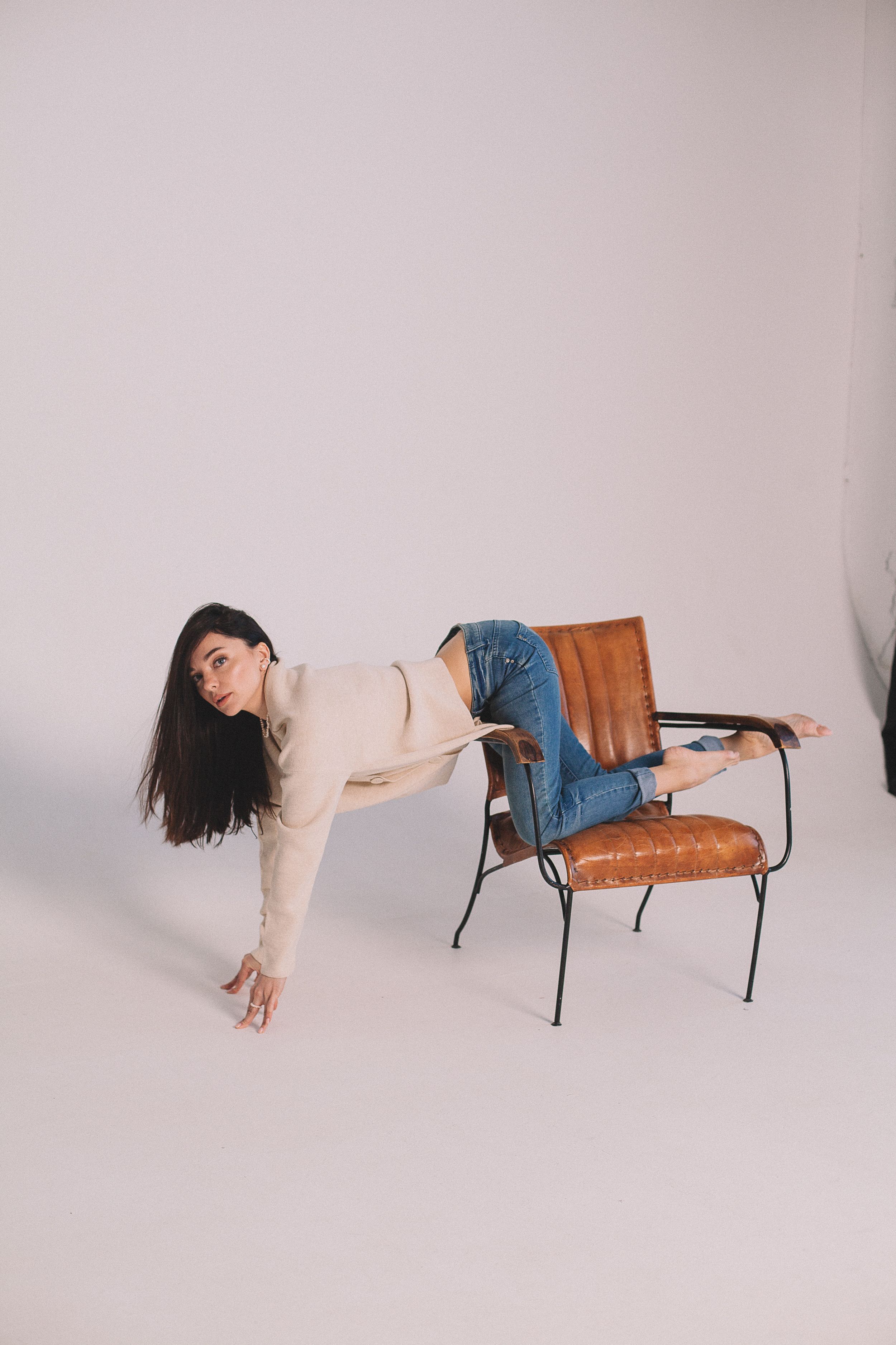 A Woman Modeling on an Armchair · Free Stock Photo