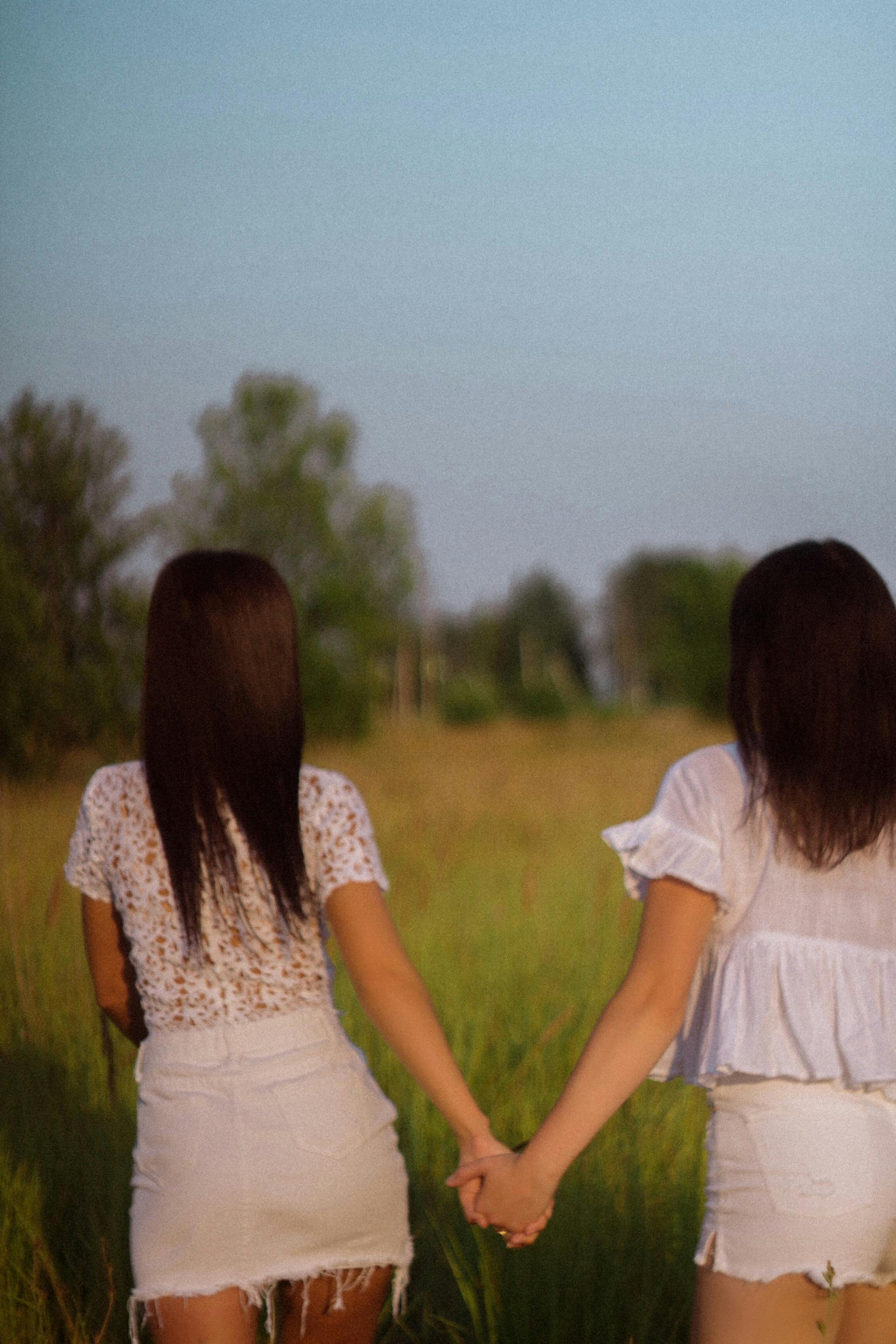 Women Holding Hands while in a Flower Field · Free Stock Photo