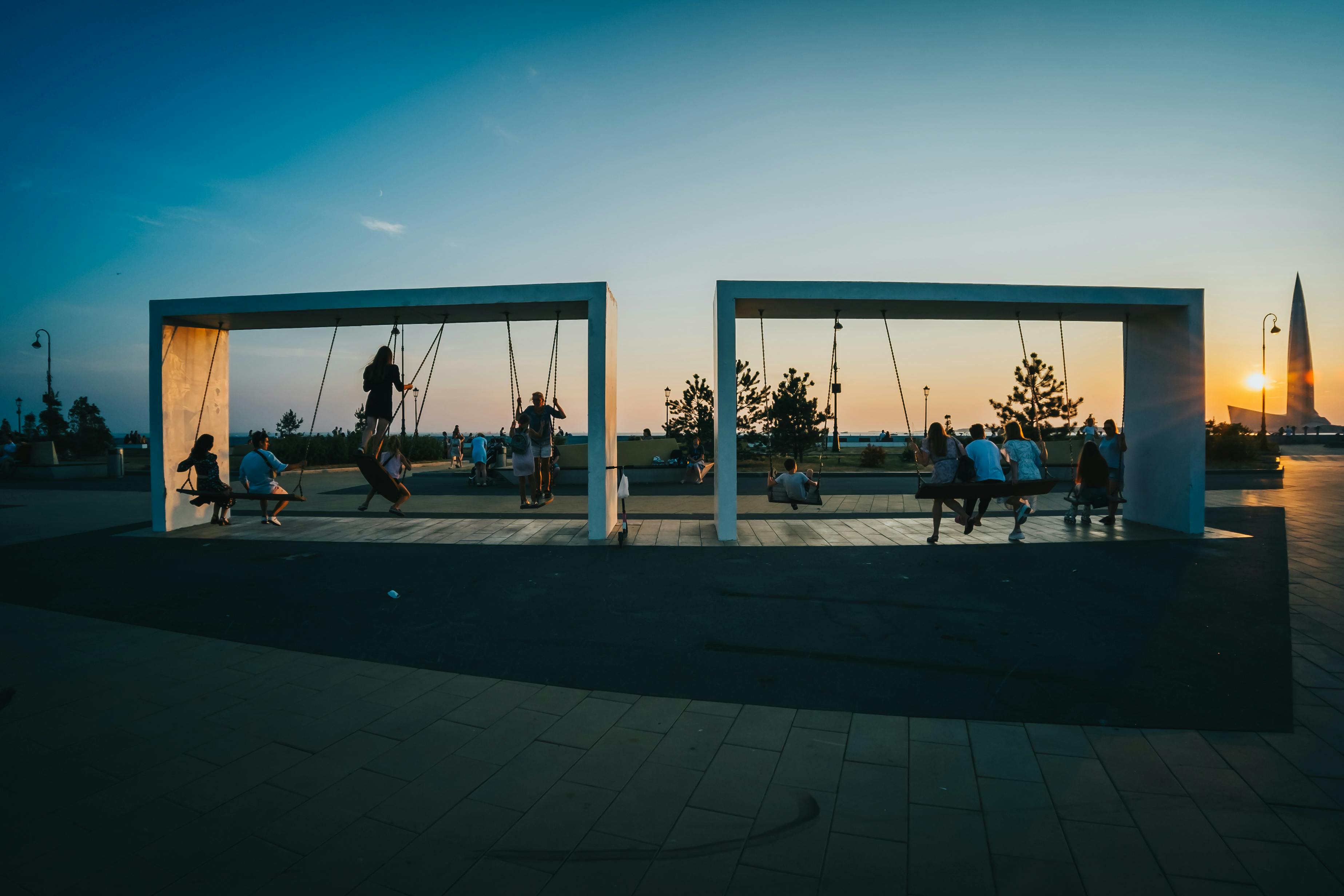 People Sitting on Long Swings · Free Stock Photo