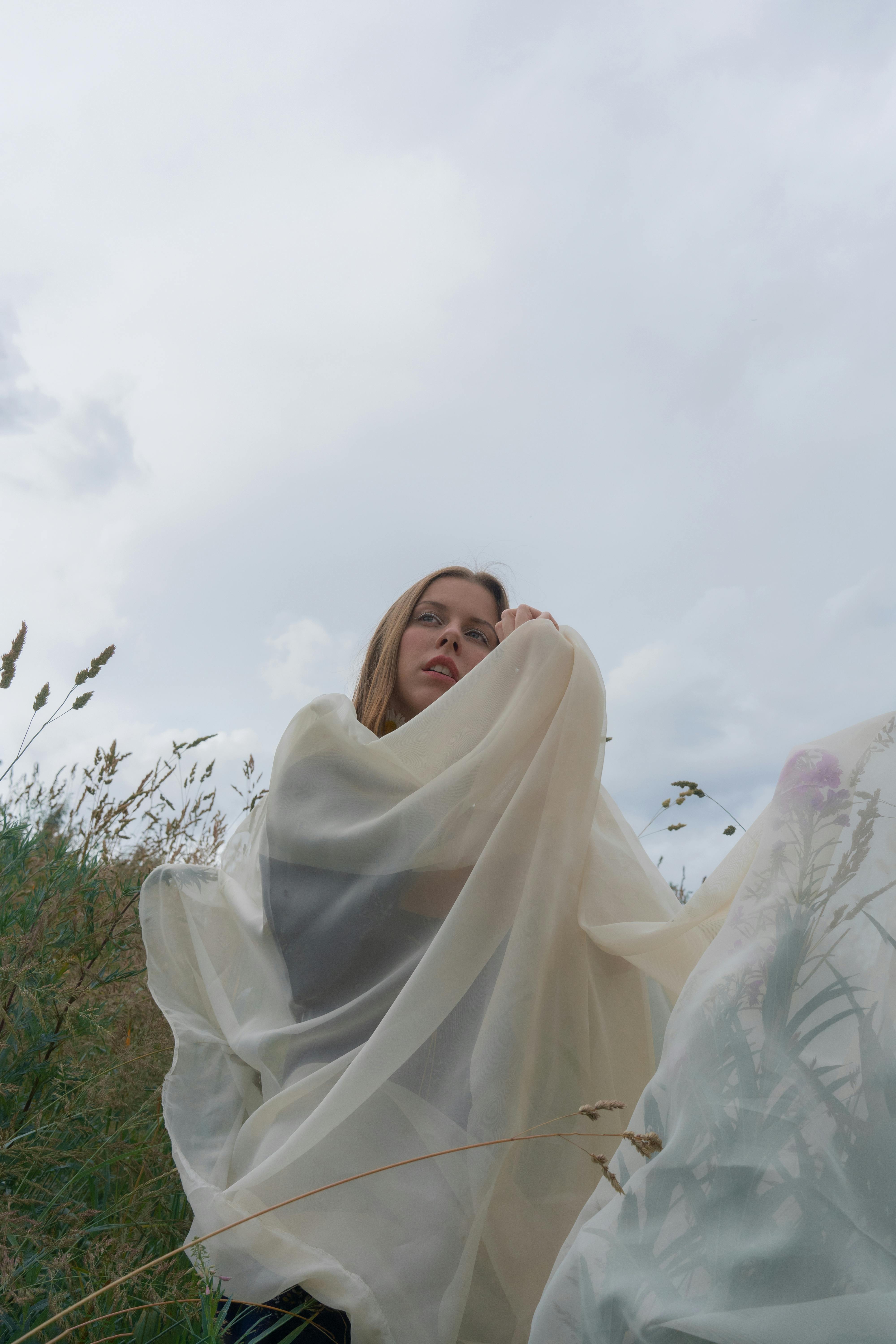 Photo of a Woman Posing with a White Cloth · Free Stock Photo