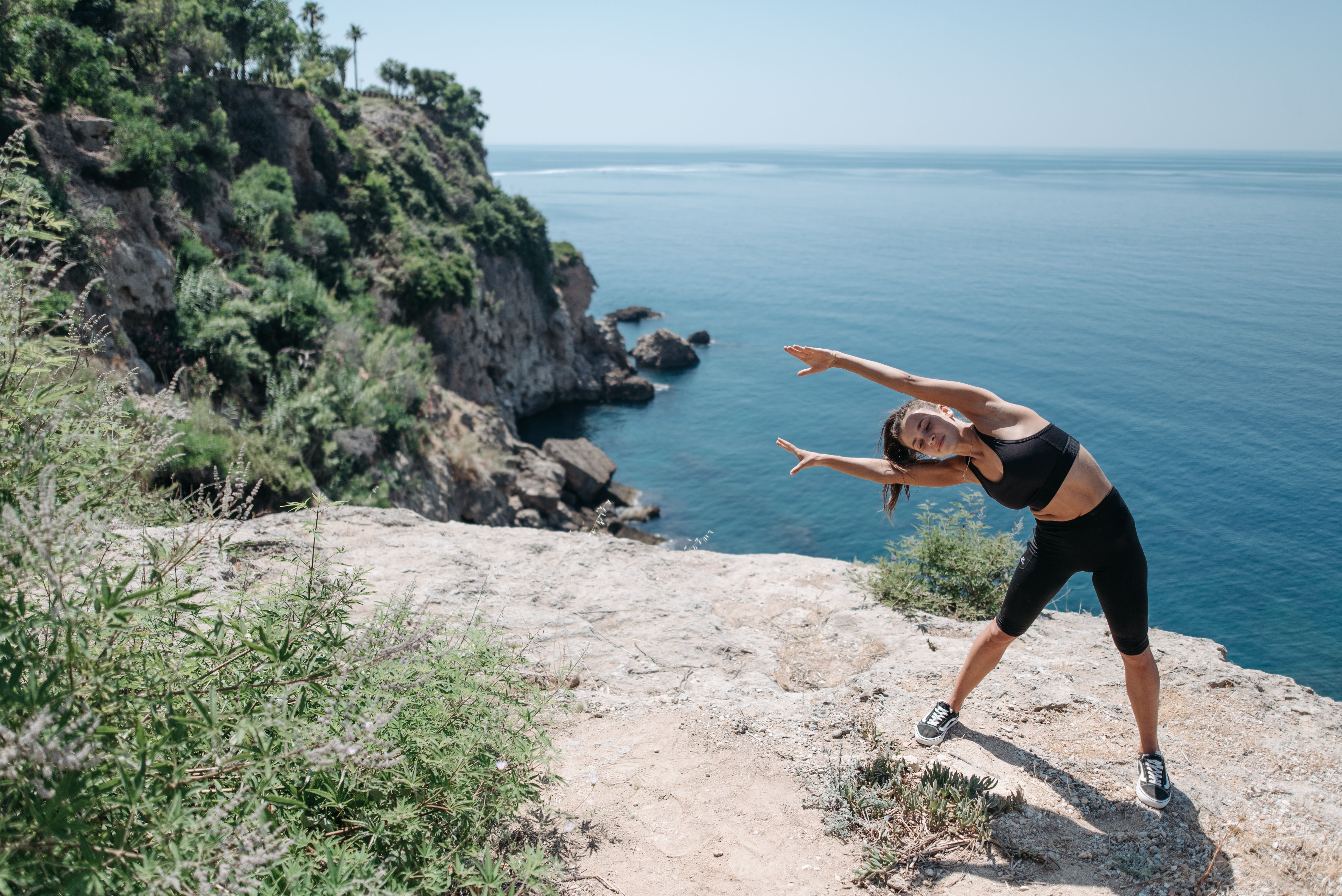 Woman in Black Sports Bra Doing Bending and Stretching Exercise on ...