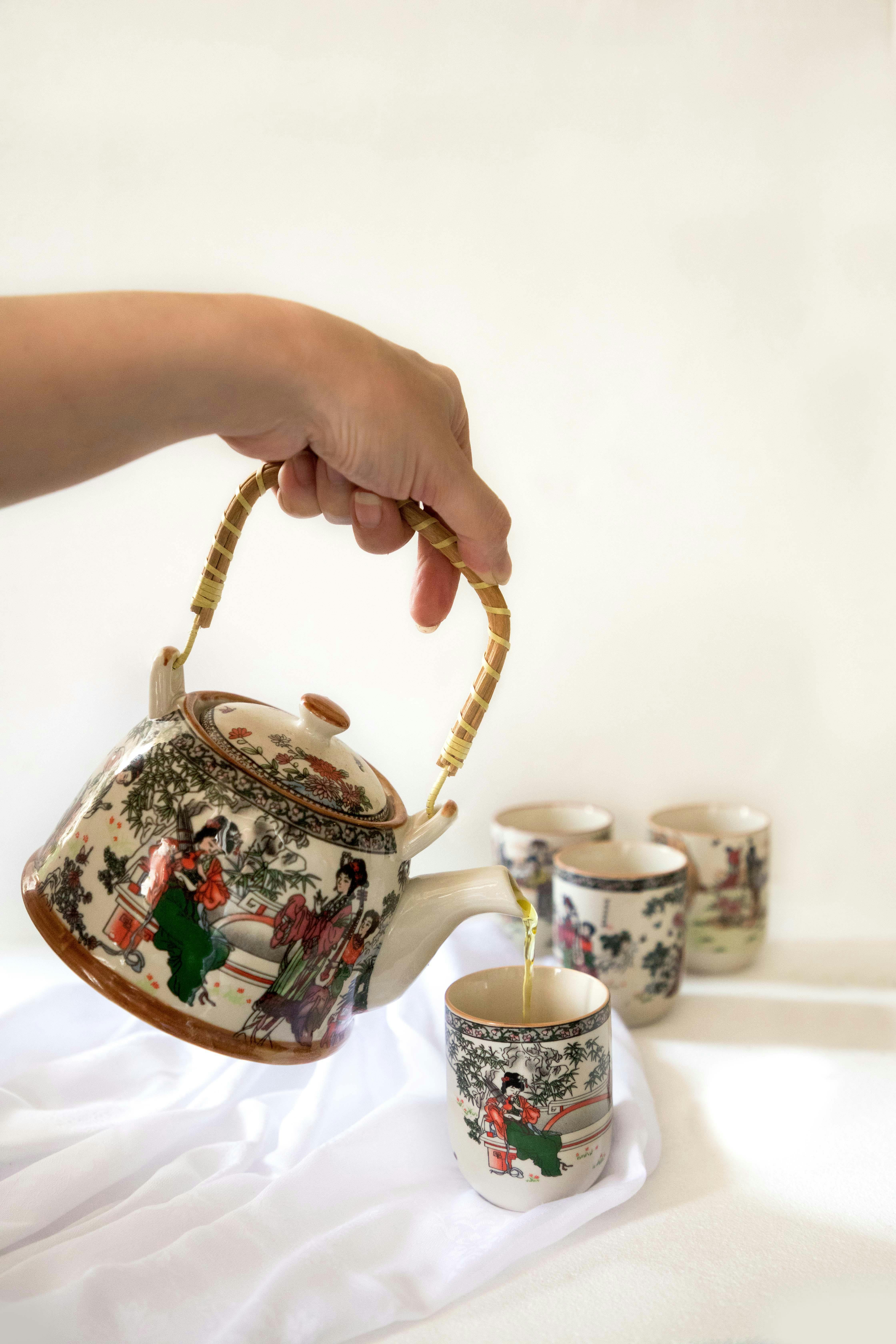 Person Holding Clear Glass Teapot · Free Stock Photo