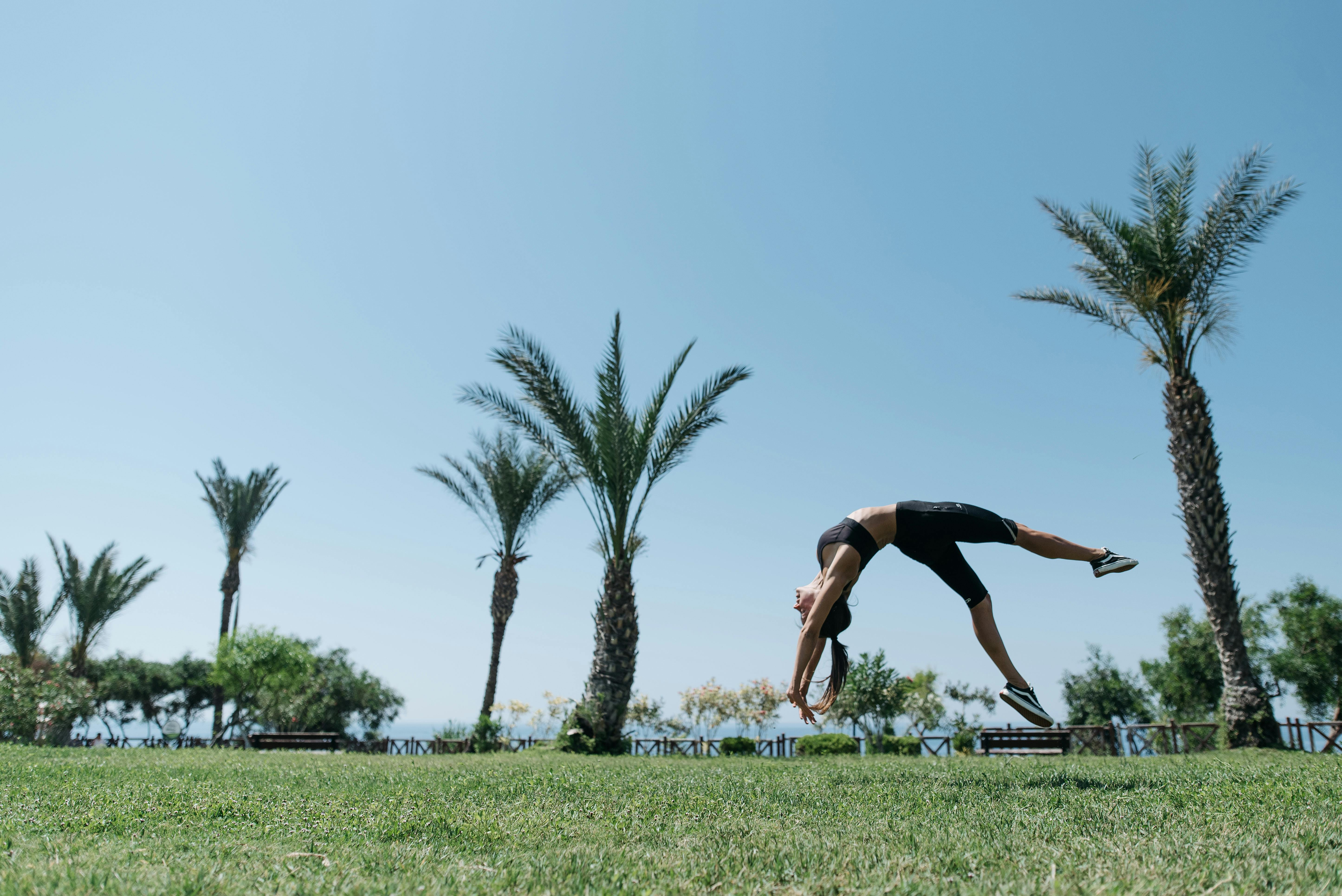 A Woman Performing a Backflip · Free Stock Photo