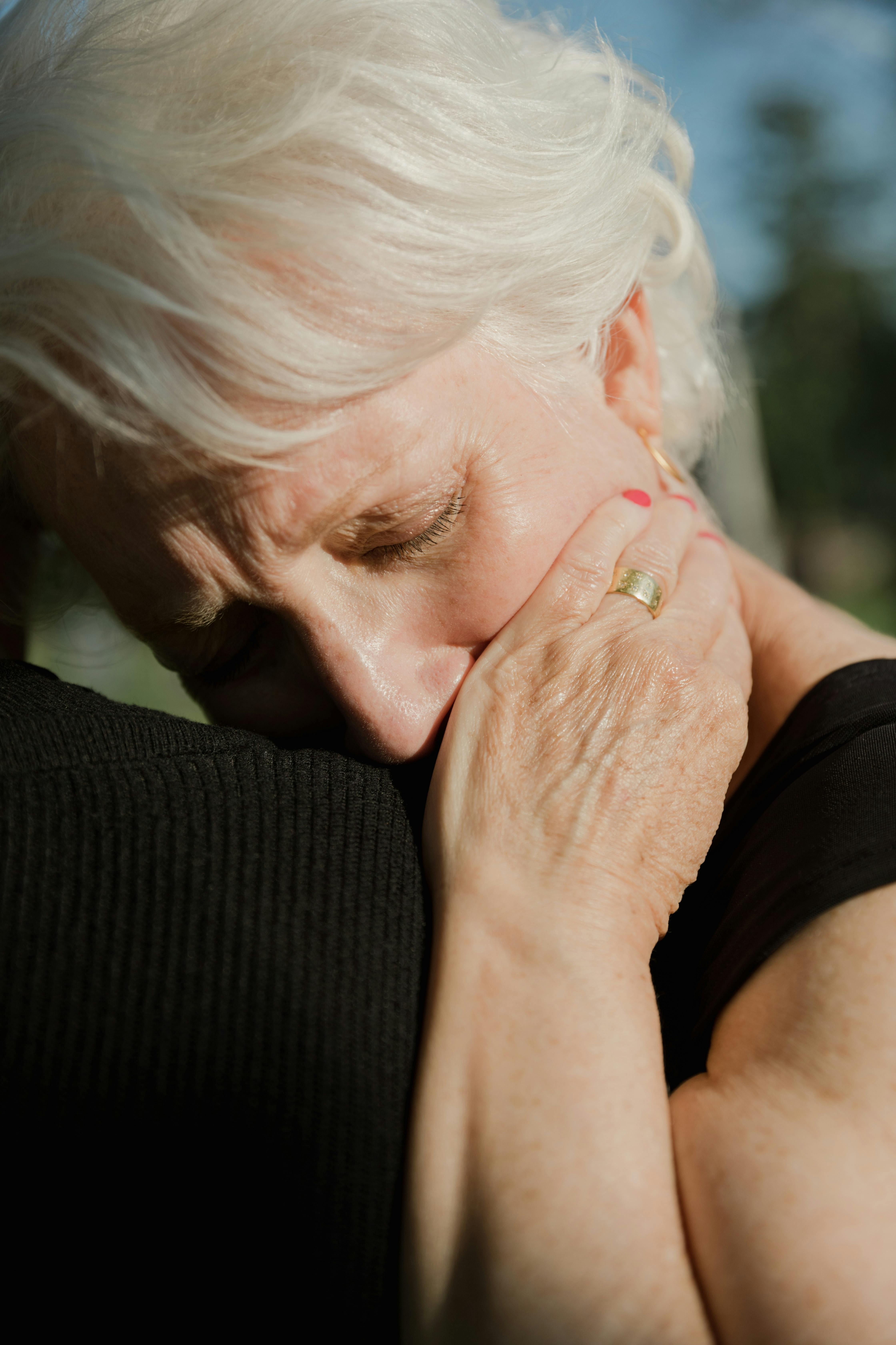An Elderly Woman Crying on Person's Shoulder · Free Stock Photo