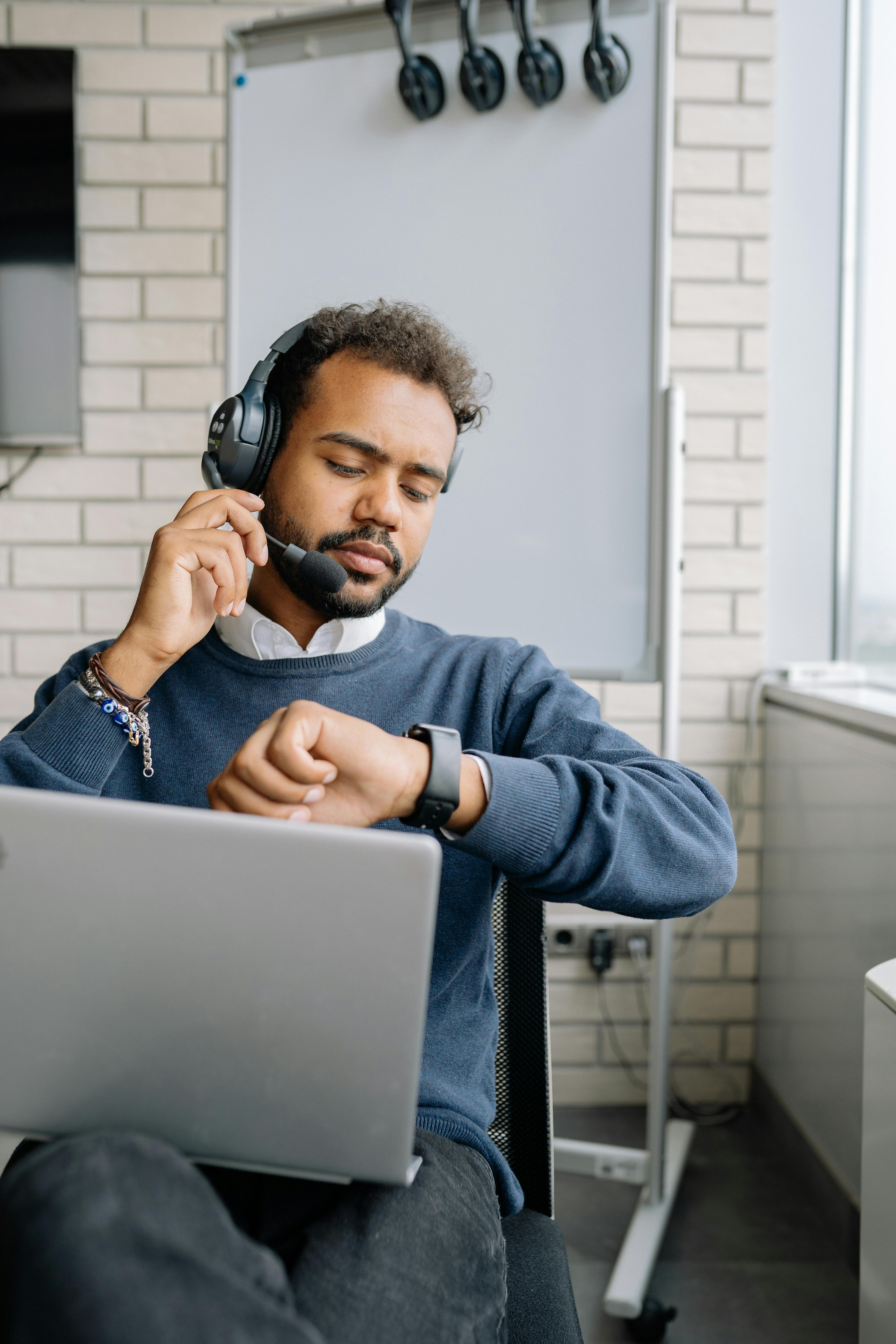 Man Wearing Headset Looking at his Watch · Free Stock Photo