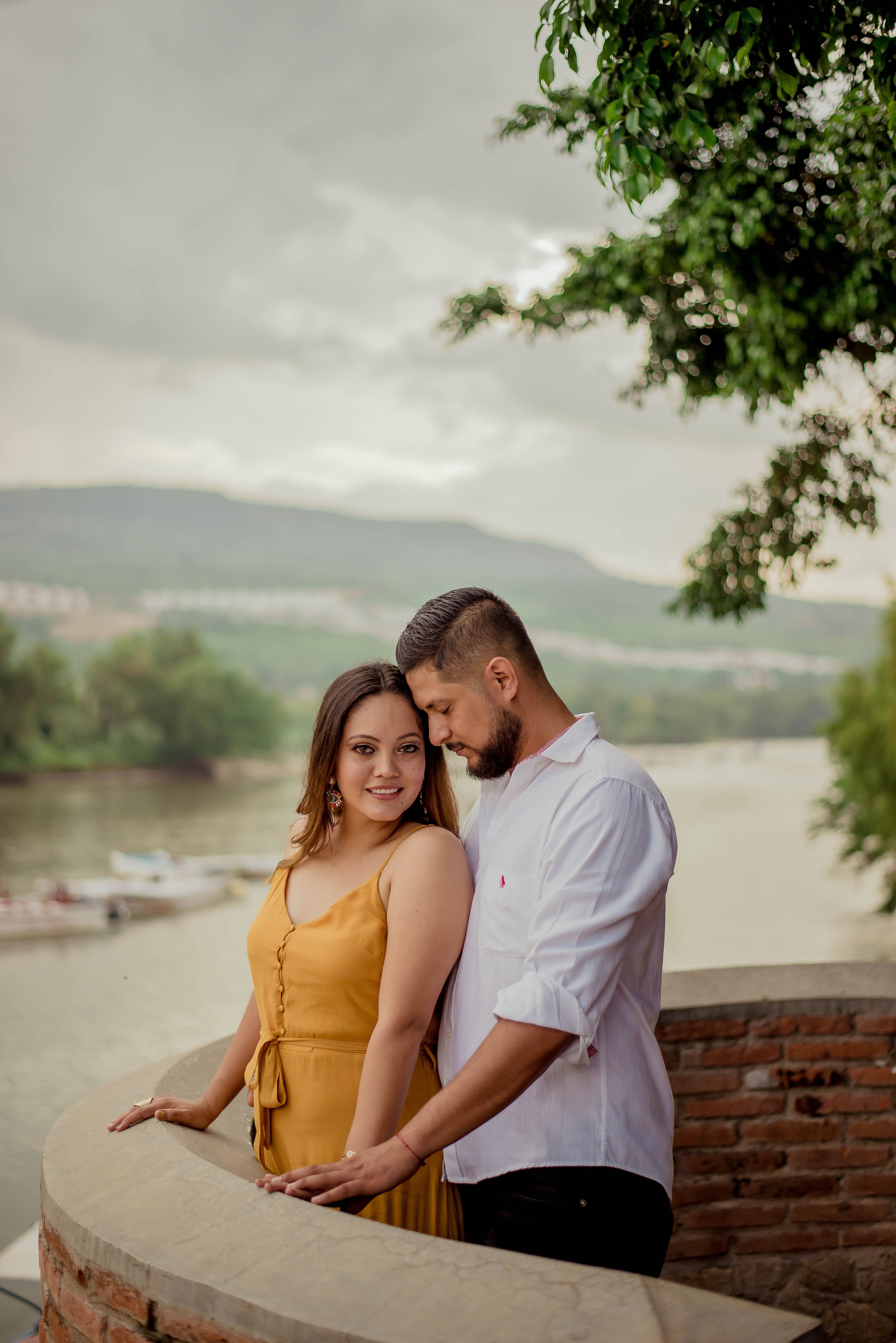 Romantic Couple Standing Together on a Concrete Balcony · Free Stock Photo