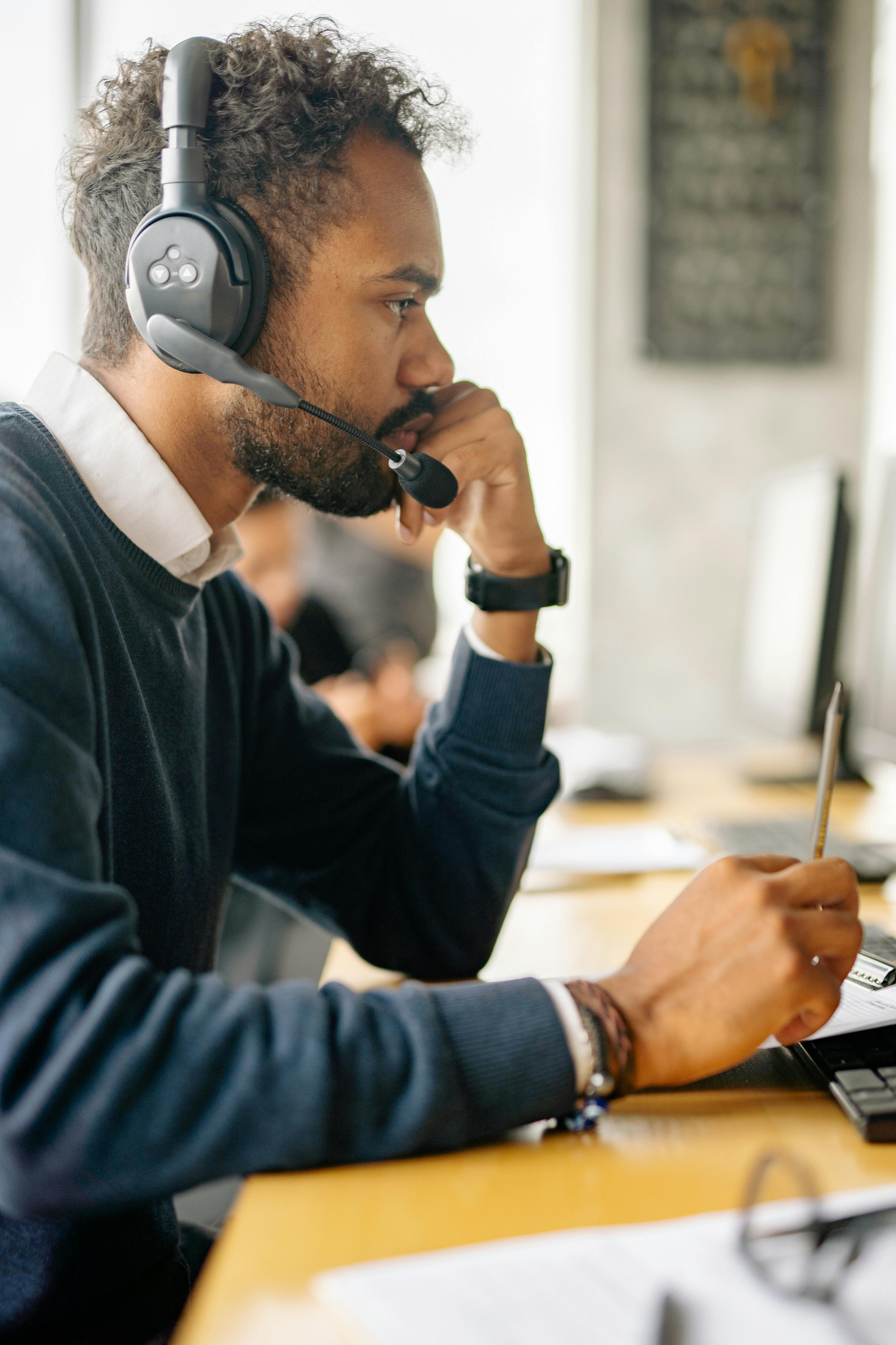 A Woman with Headset Inside a Gray Cubicle · Free Stock Photo