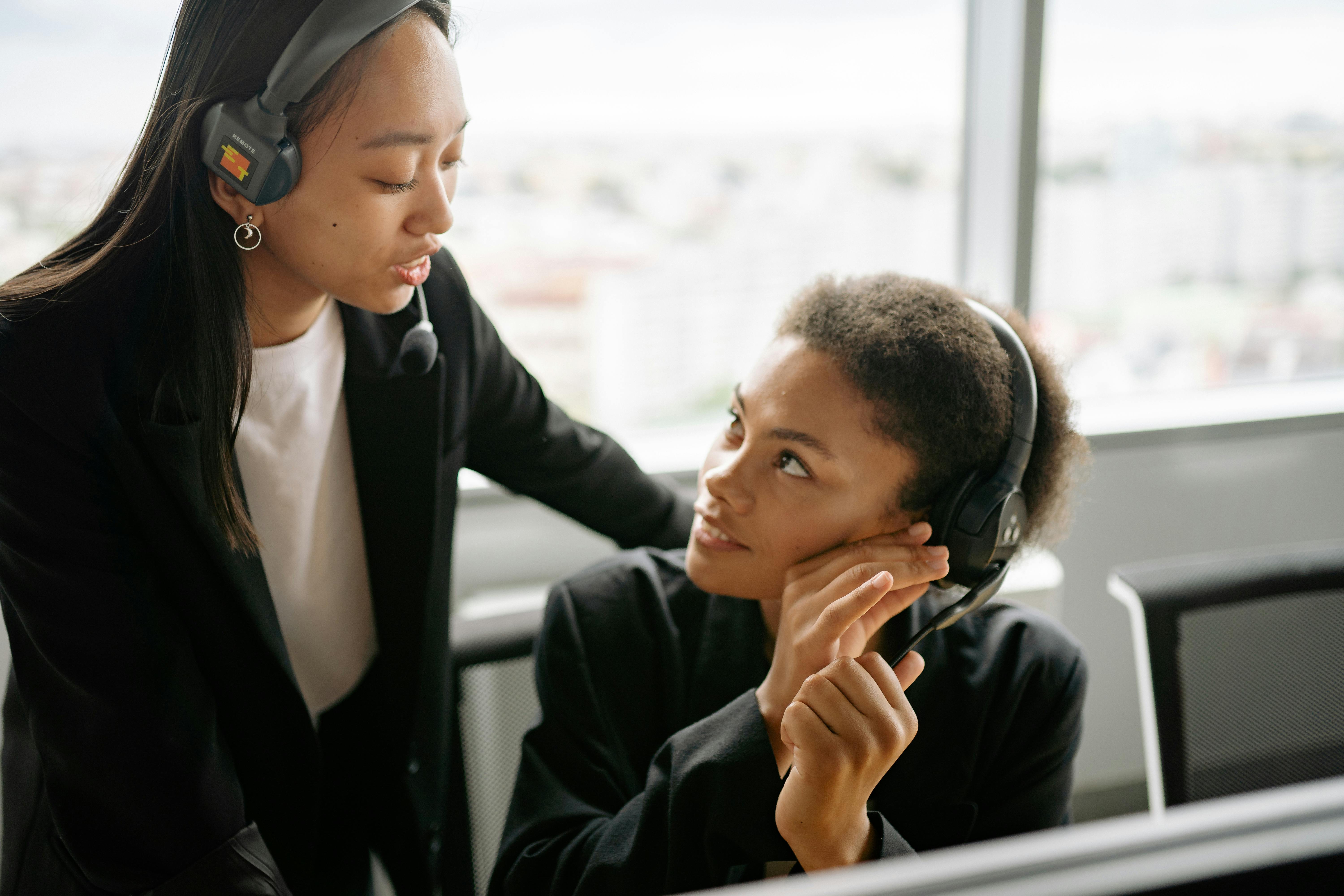 A Woman with Headset Inside a Gray Cubicle · Free Stock Photo